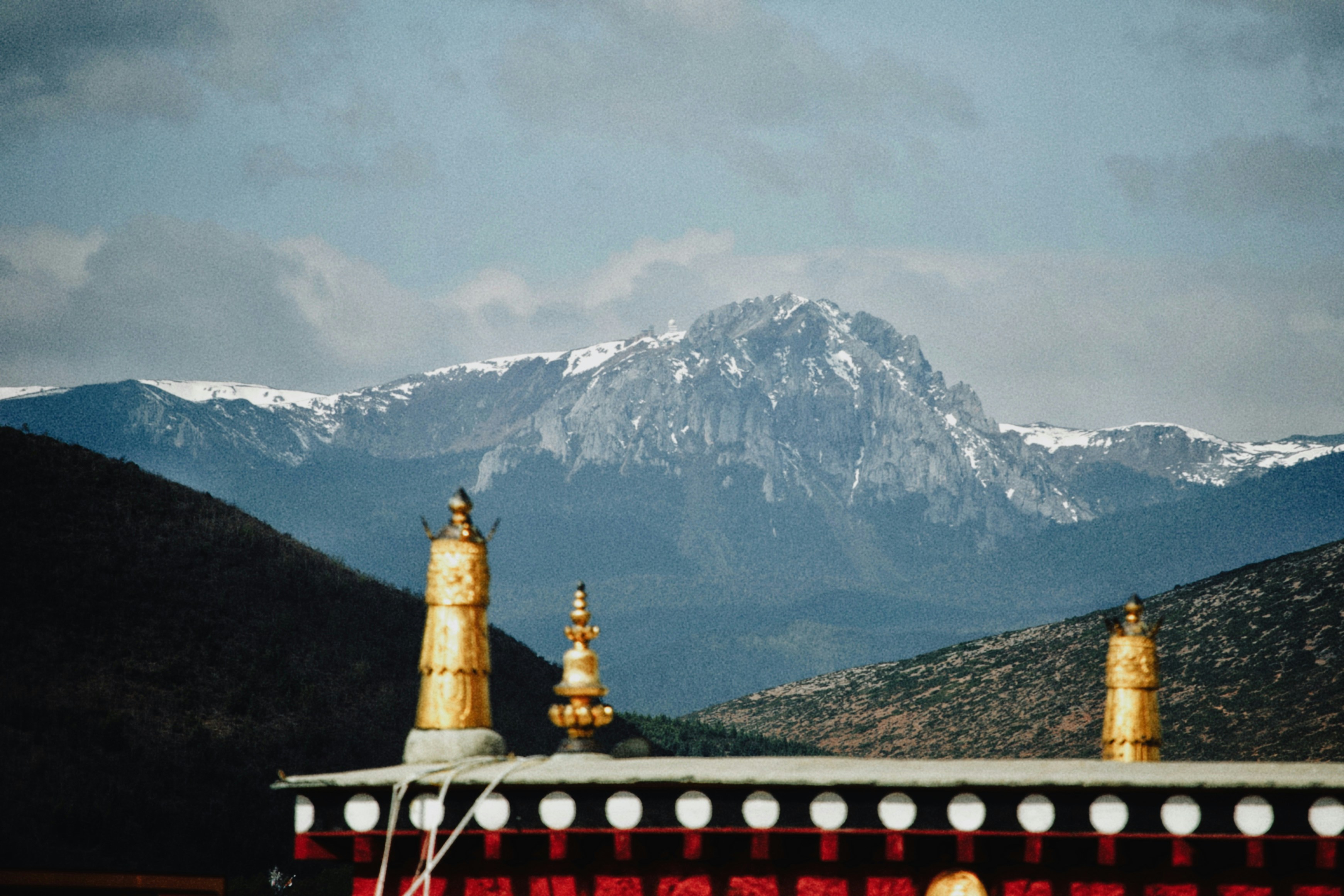 Snow-Capped Peaks over a Tibetan Temple Mesh