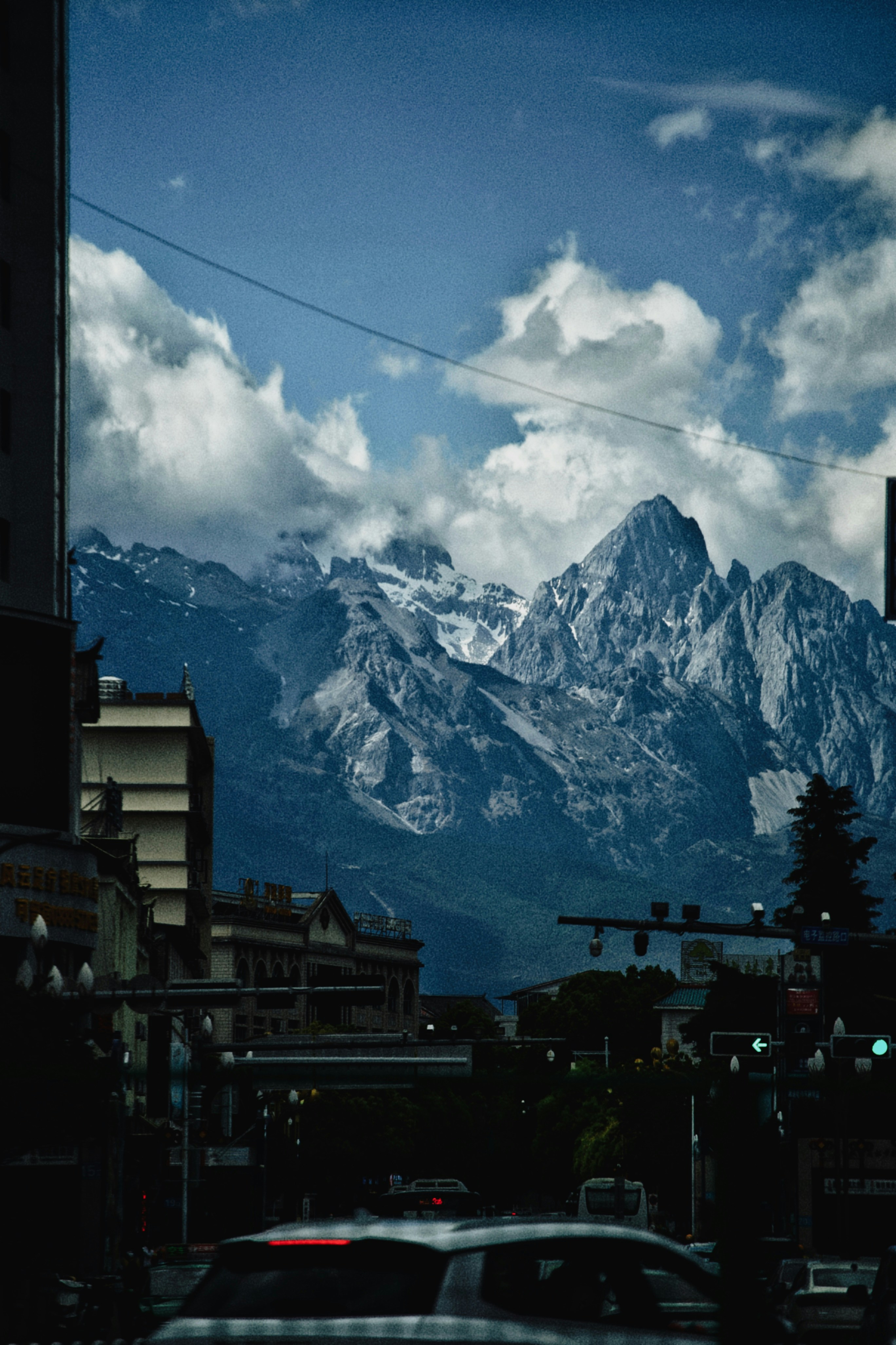 Midtown Backbone: Alpine Peaks Loom Over a Quiet Street