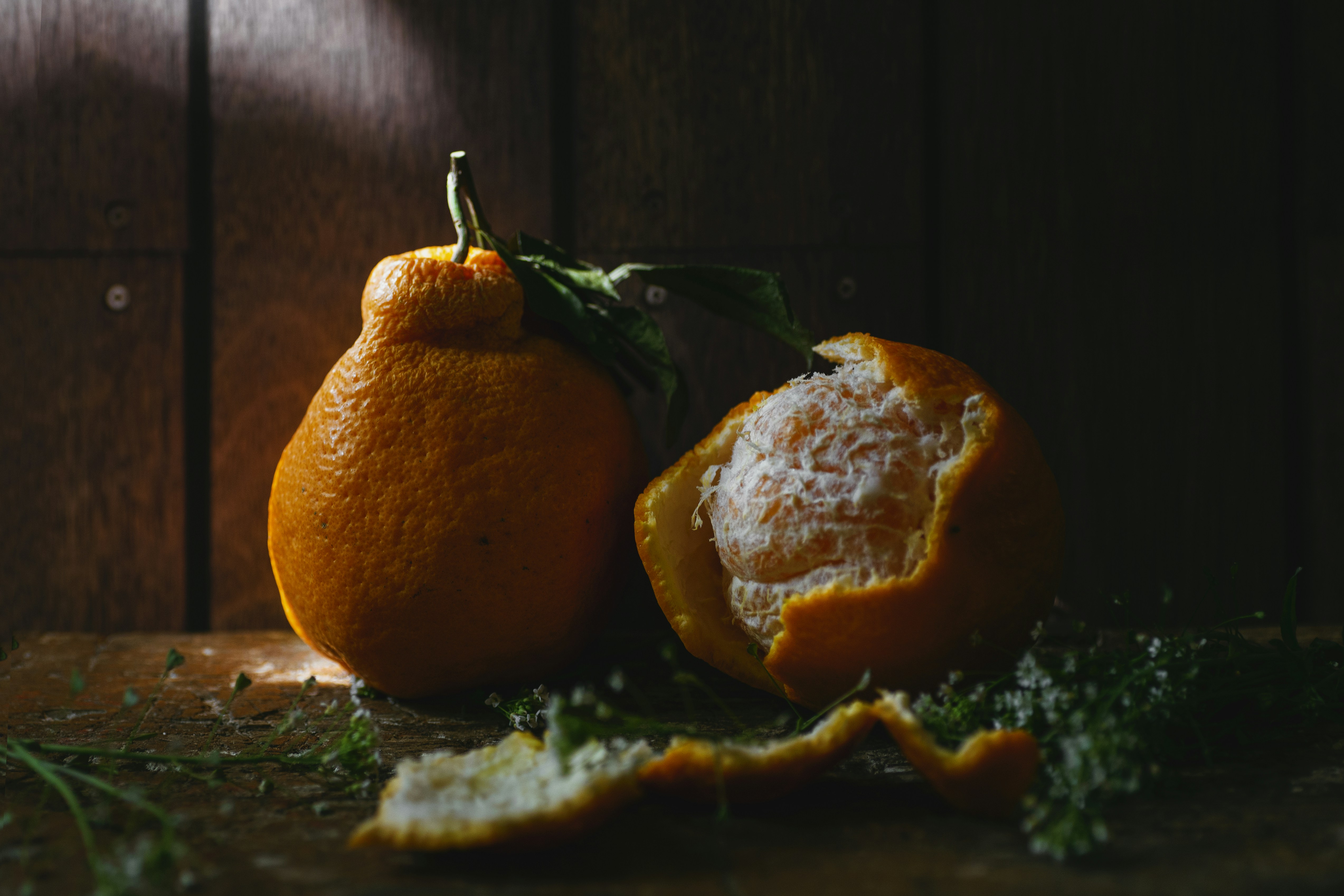 Peel of Contrast: A Pair of Oranges Resting on a Wooden Stage