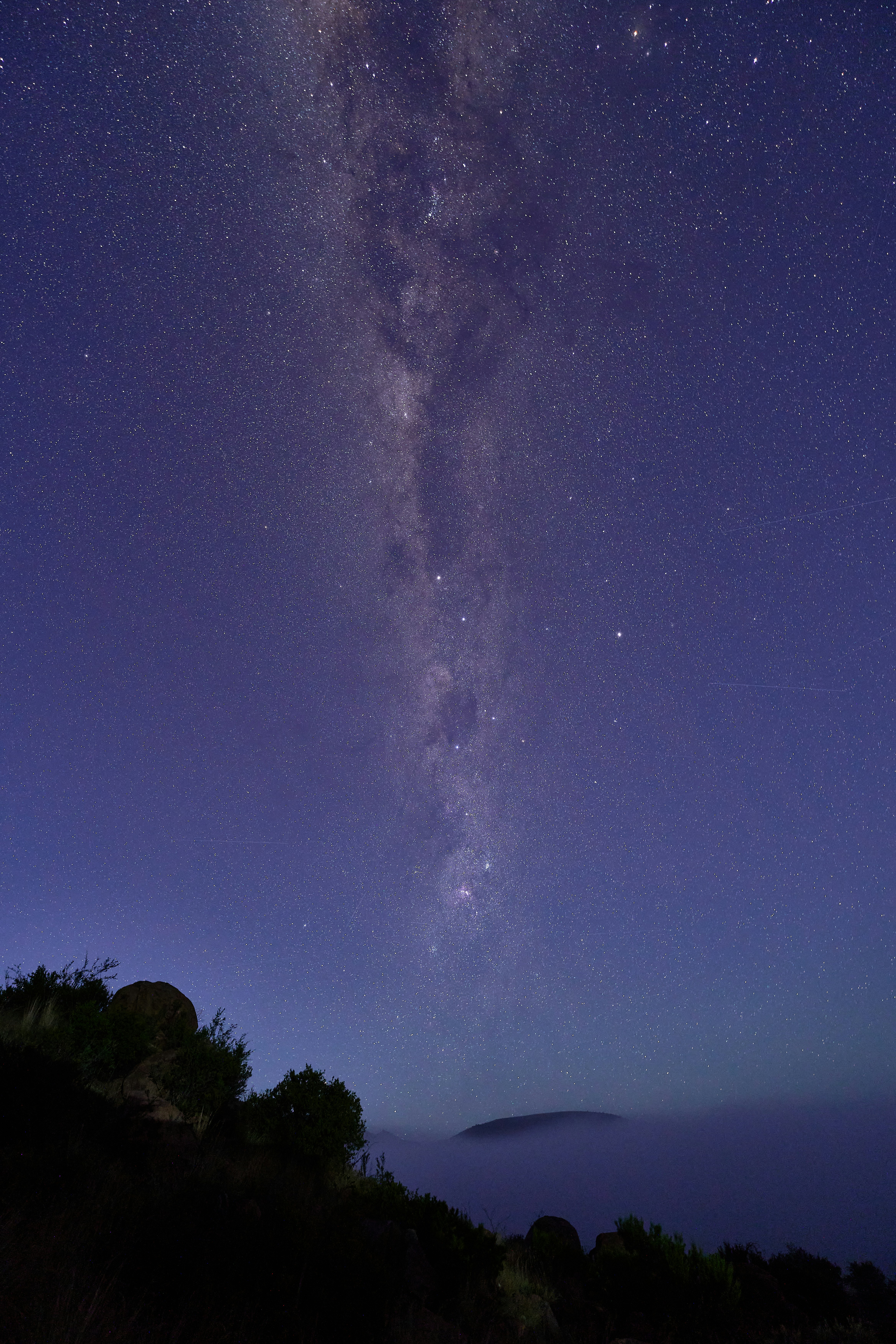 Milky Way Over Quiet Horizon: A Nightscape Above Misty Hills