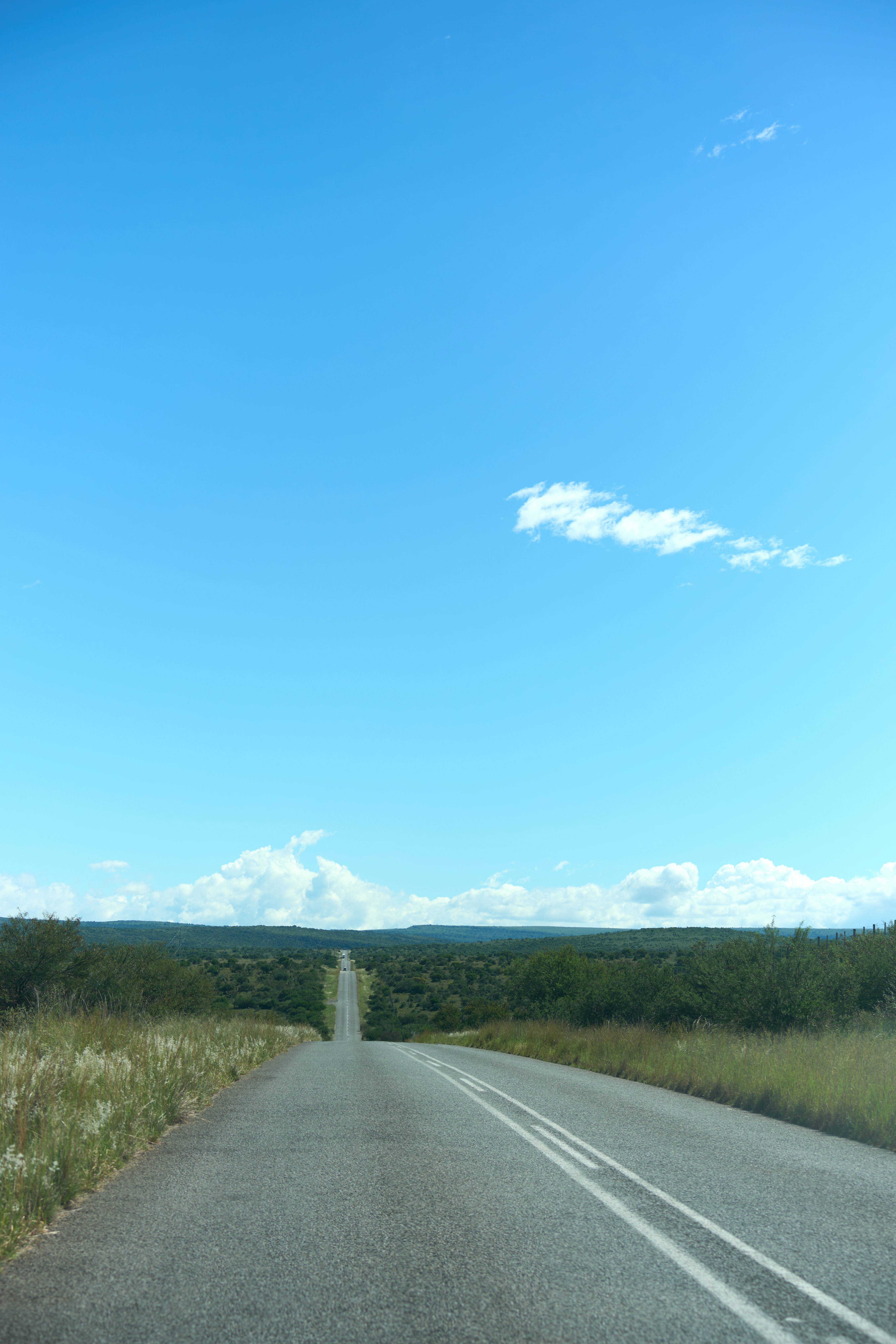 Endless Road Under a Wide Blue Sky