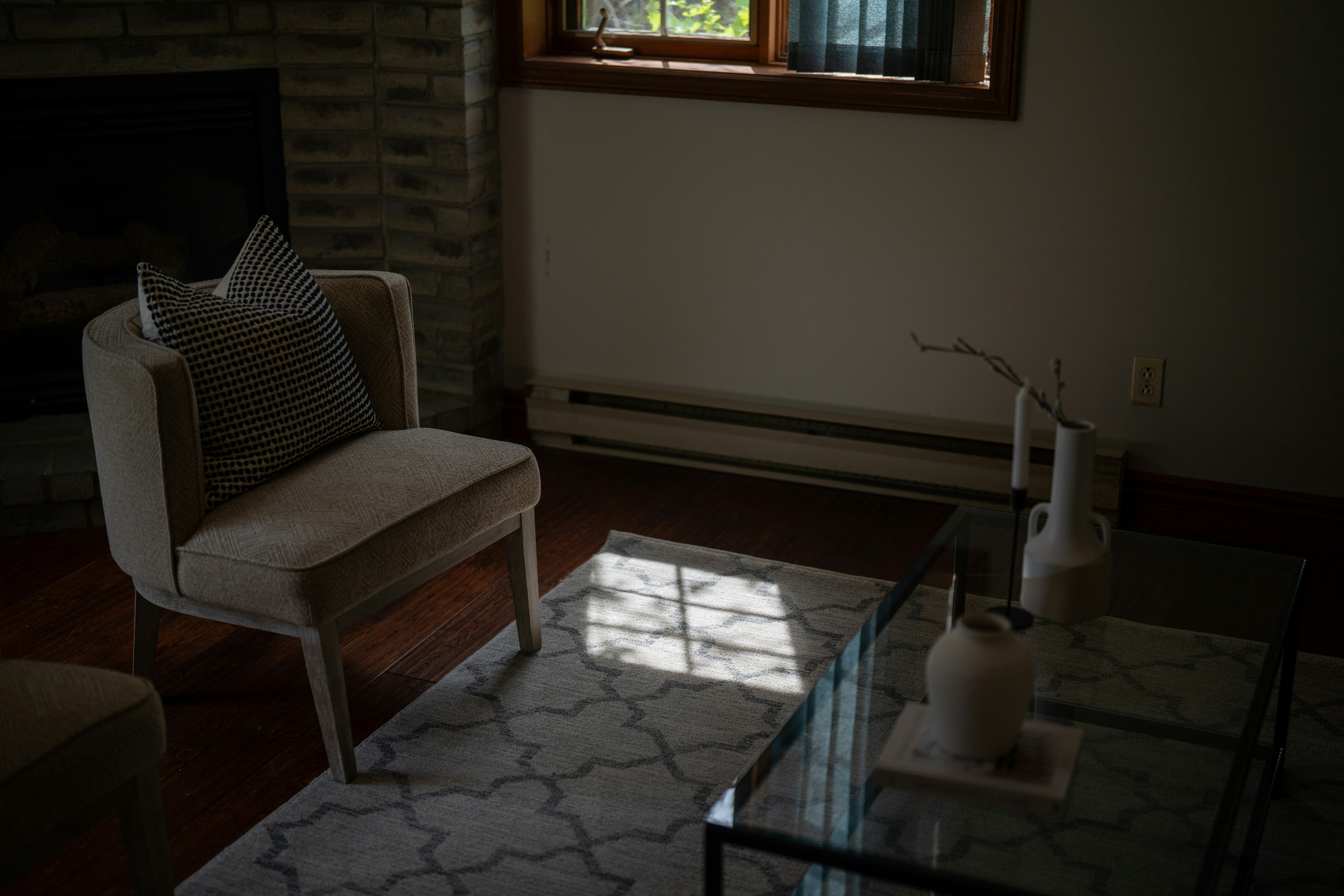 Low-lit Living Room Quiet: Sunlit Patch on Glass Coffee Table