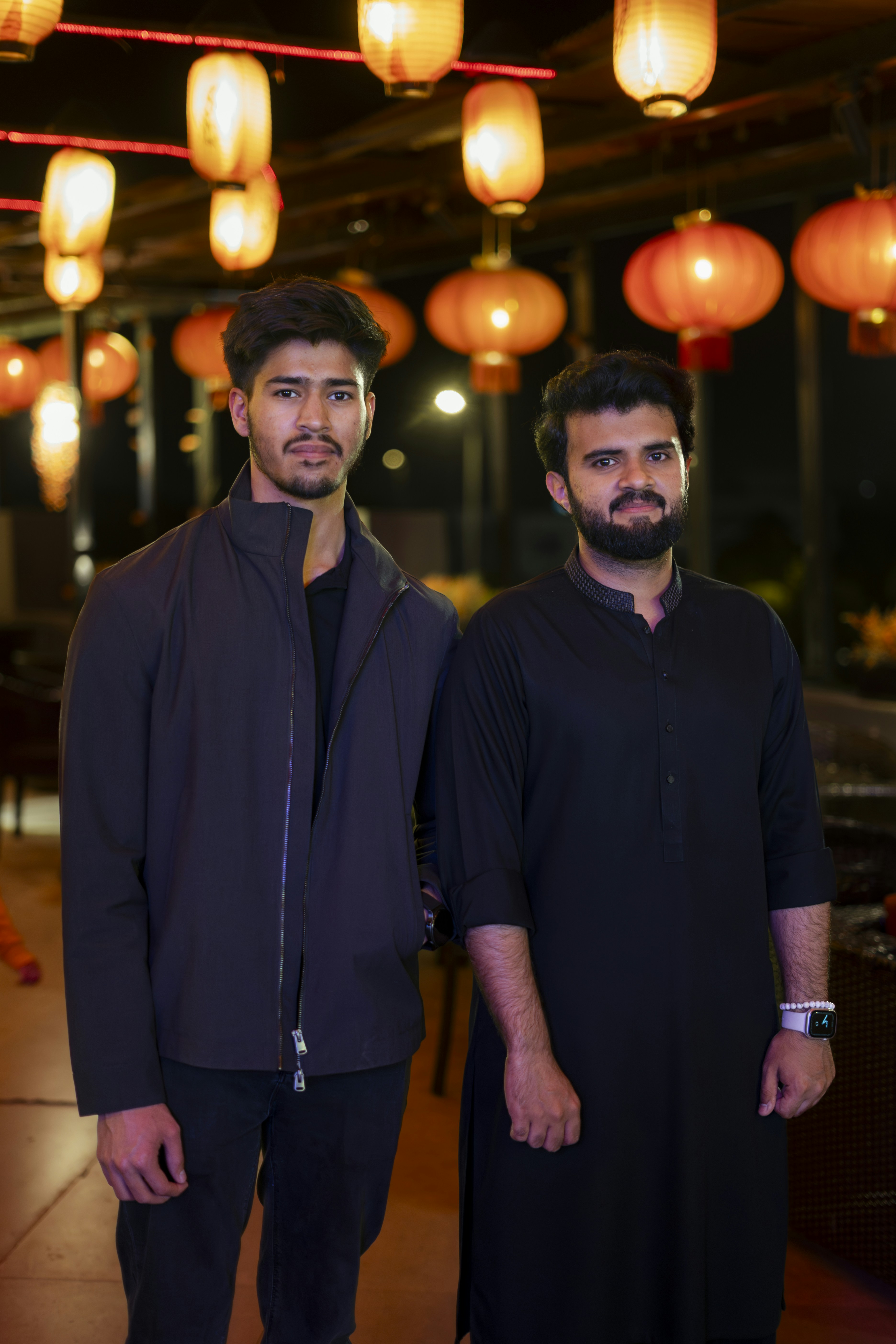 Two Friends Under Floating Lanterns: Nightlife in Warm Red