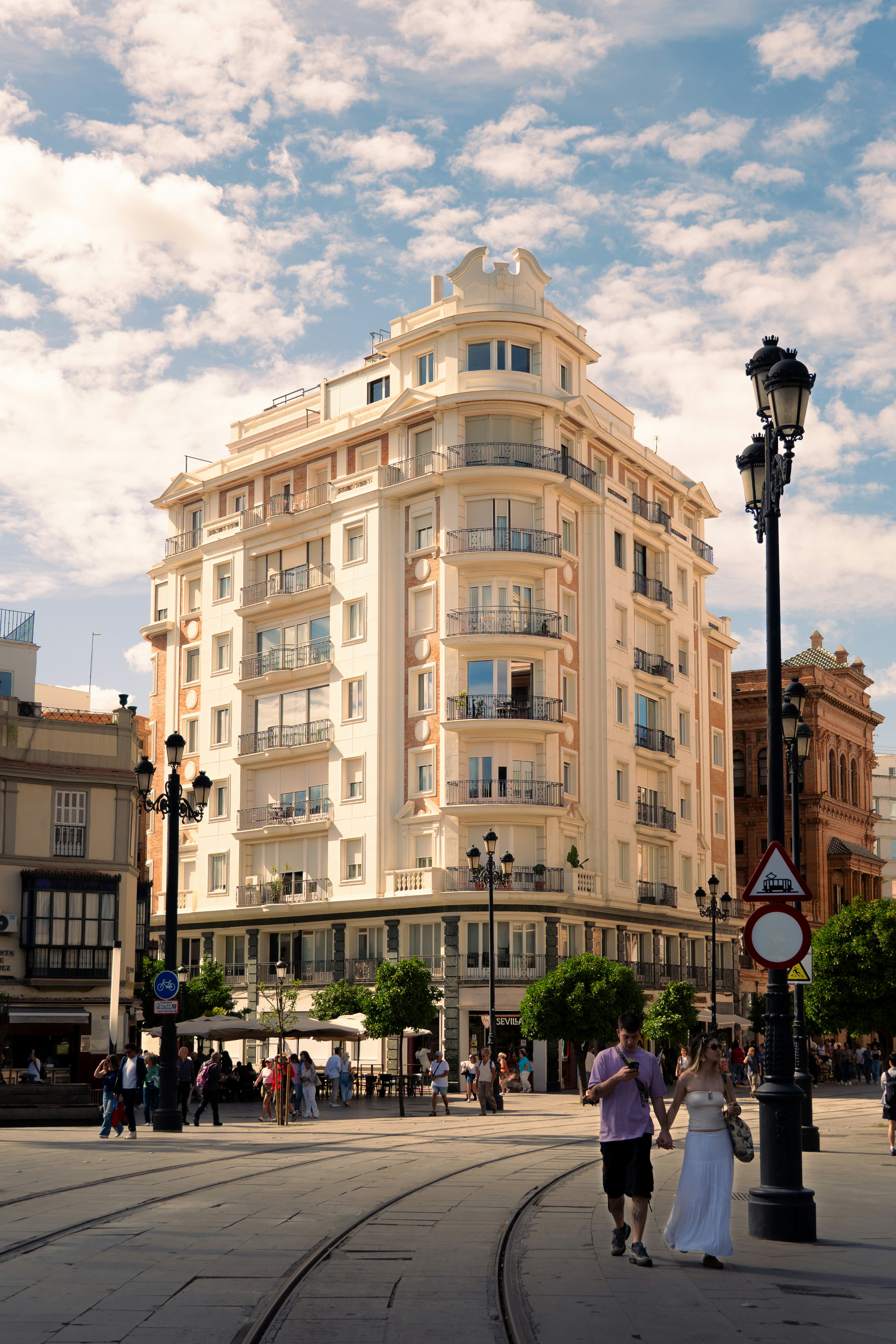 Sunlit Mediterranean Facade Amid a Busy Plaza