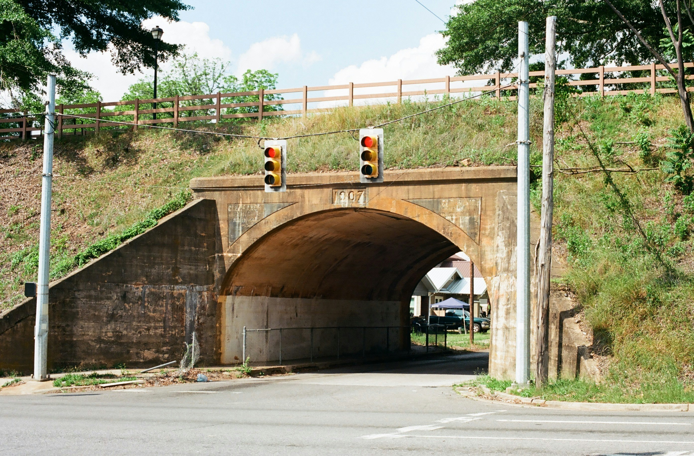Sunlit Underpass Face: A Quiet Street Corridor Beneath the Bridge