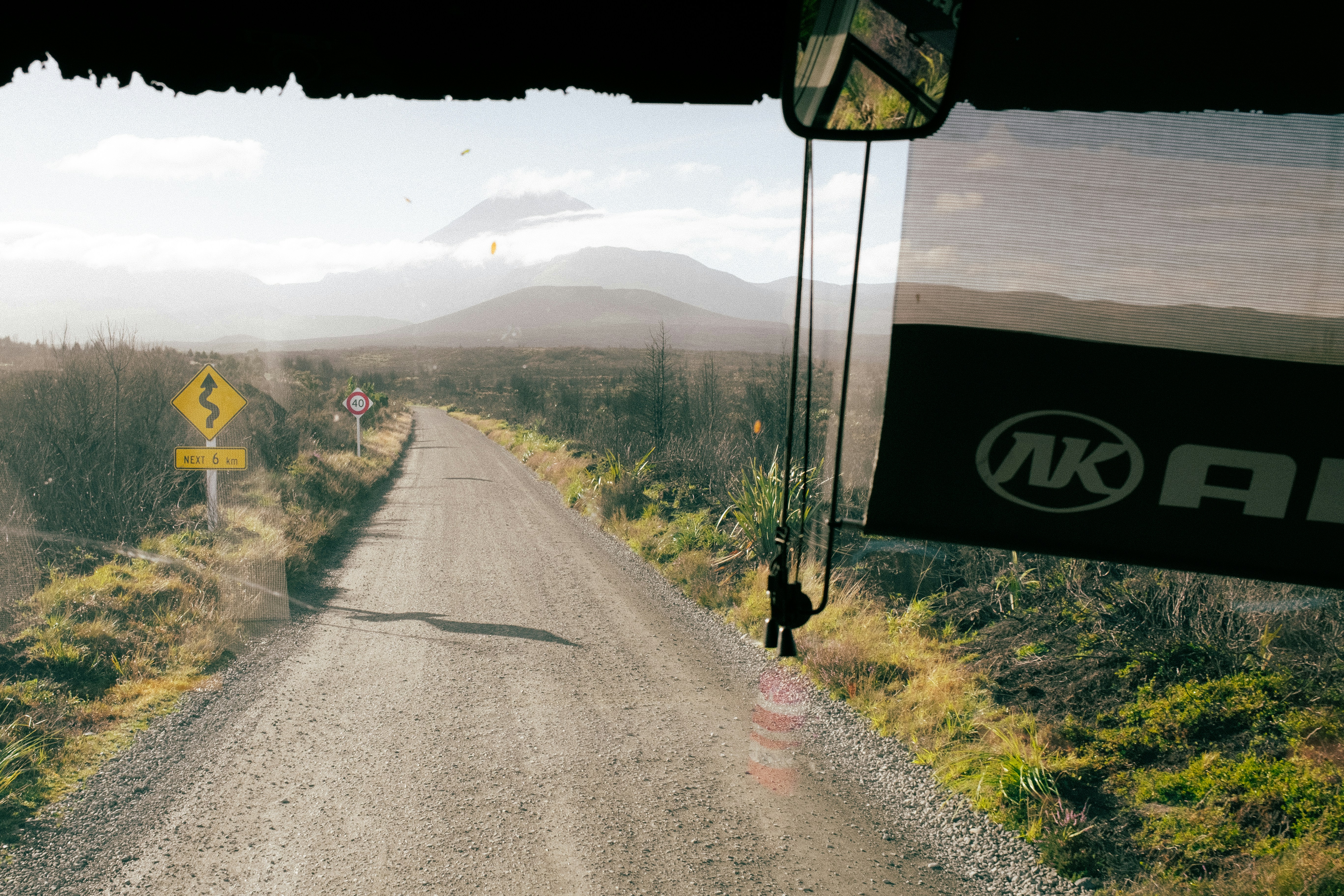 Rugged Gravel Road Toward Distant Hills