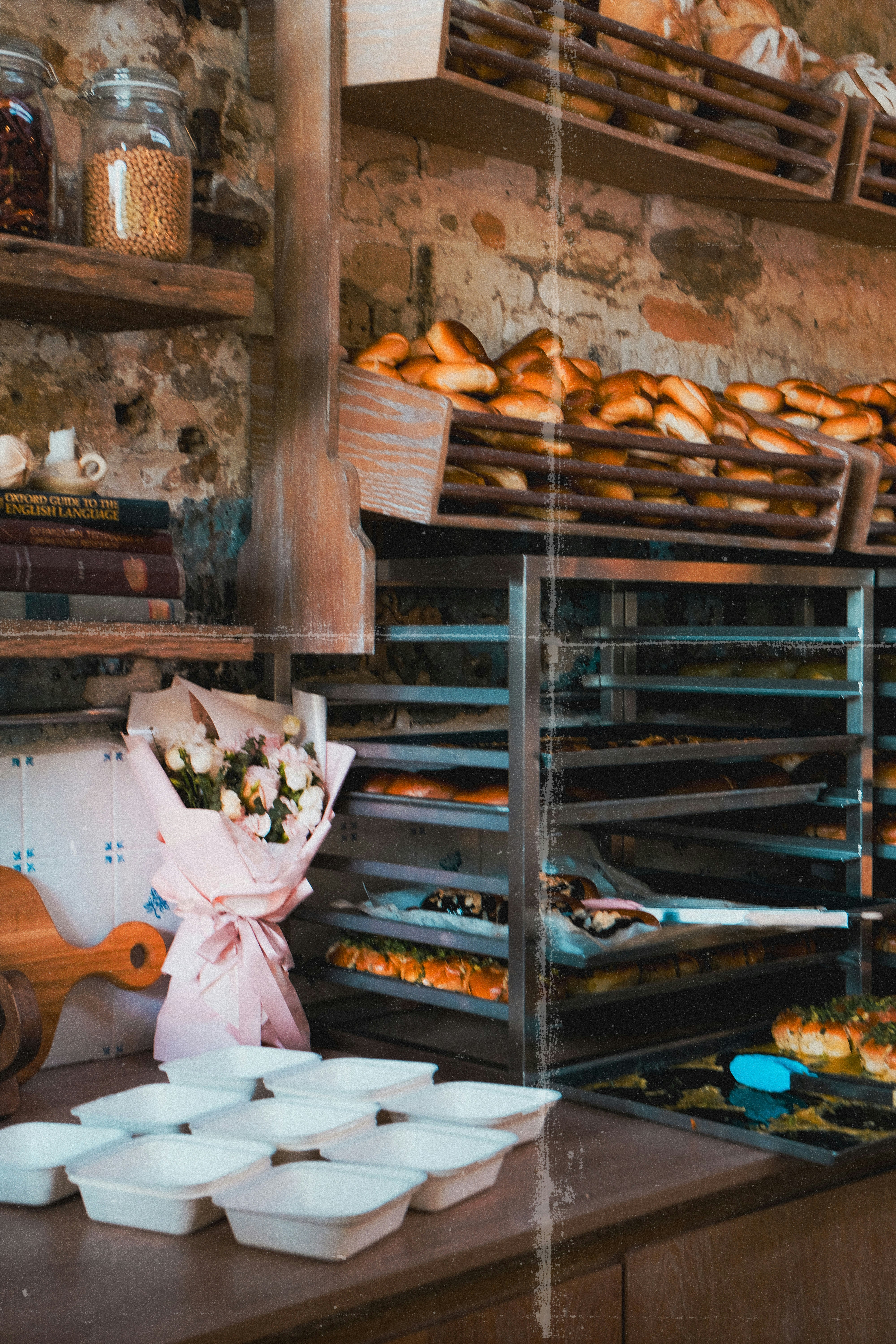 Warm Bakery Display: Bread Crates and Floral Bouquet at Sunset Cozy