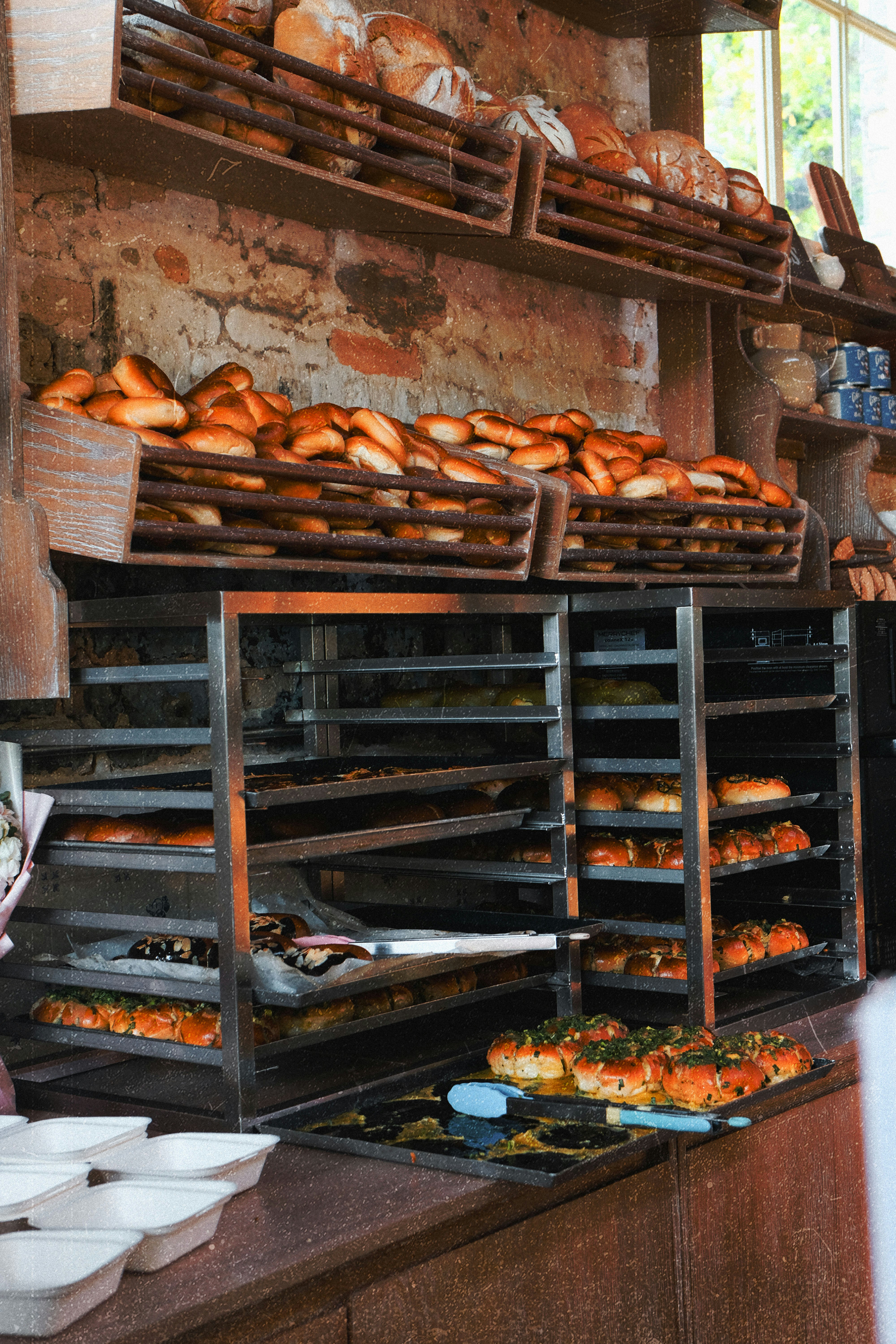 Bakery Display: Rows of Golden Buns and Fresh Pastries in a Rustic Kitchen