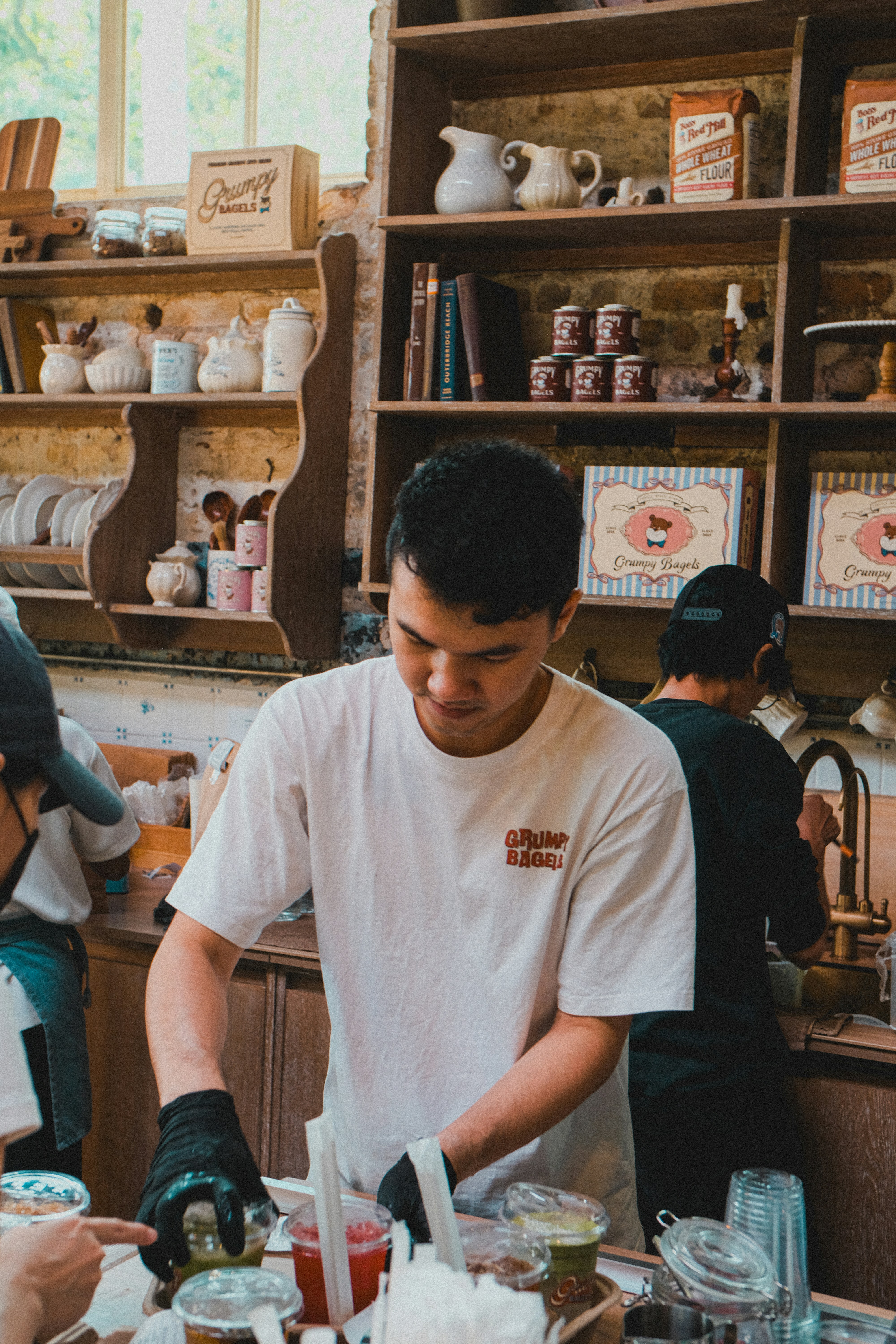 Cafe Workshop: Barista in White Amid Colorful Jars