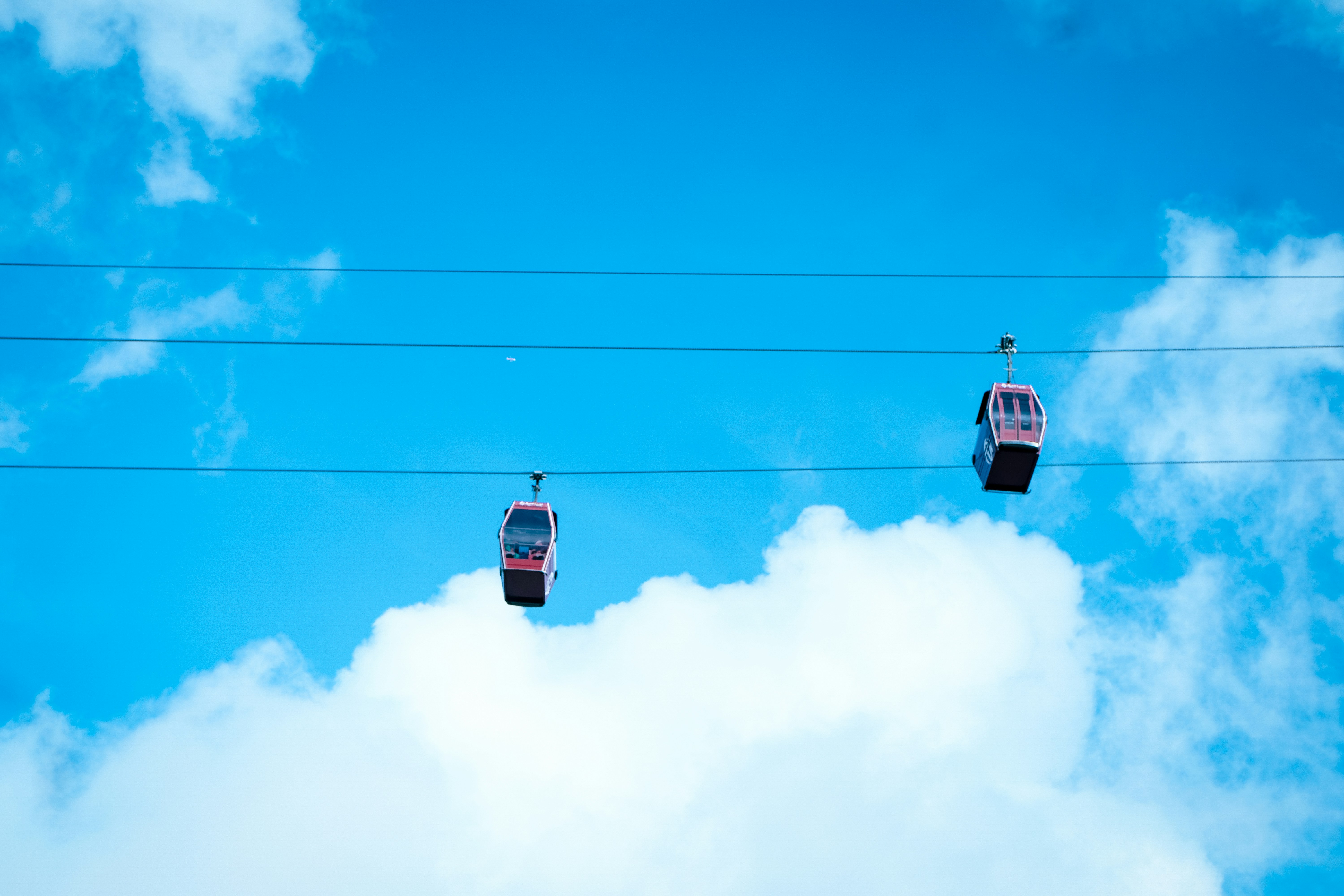 Skyward Cars: Carnival of Cables Under a Cerulean Sky