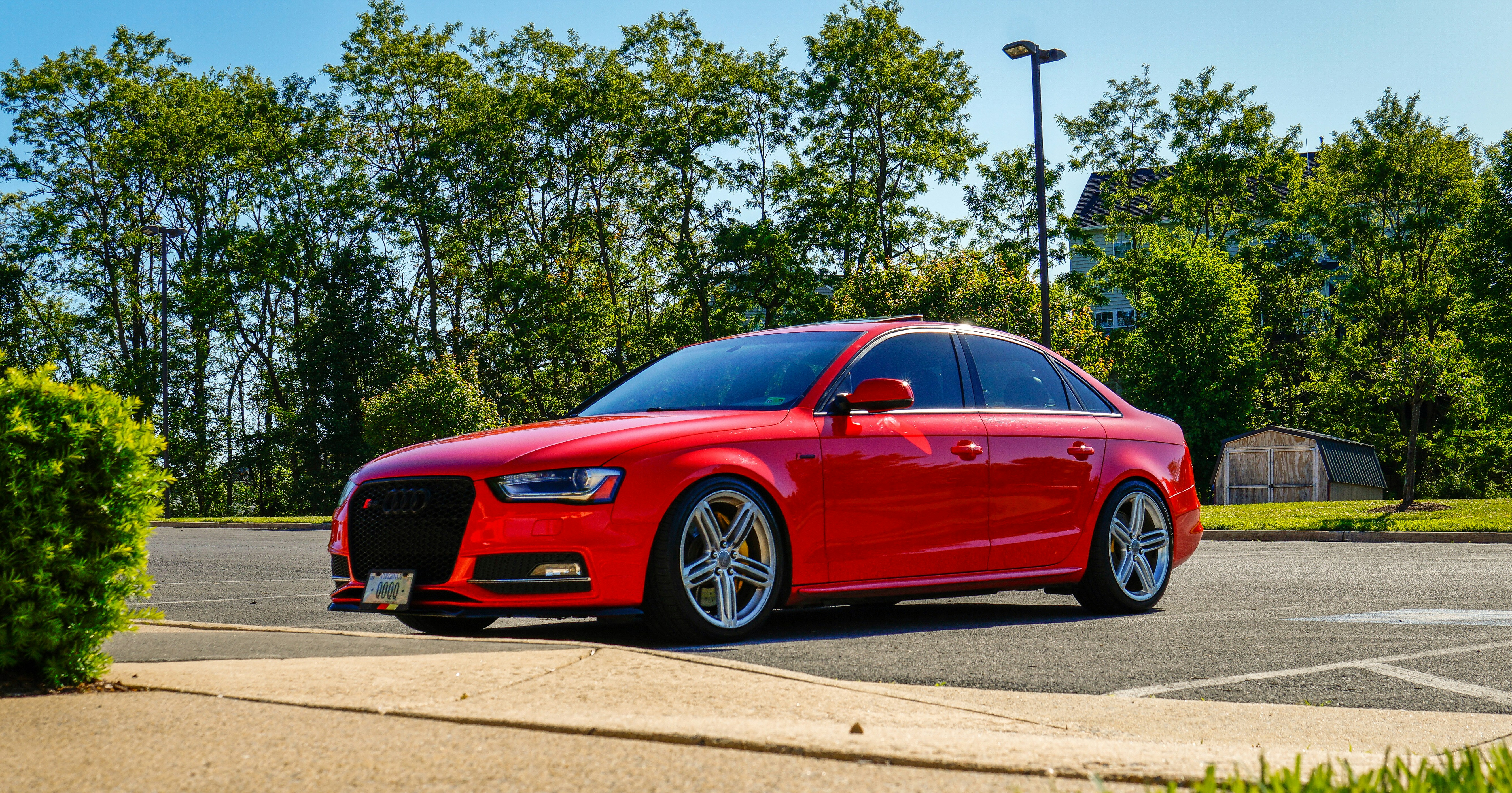 Red Audi in Sunny Parking Lot: A Low-Angle Stance with Sharp Detail