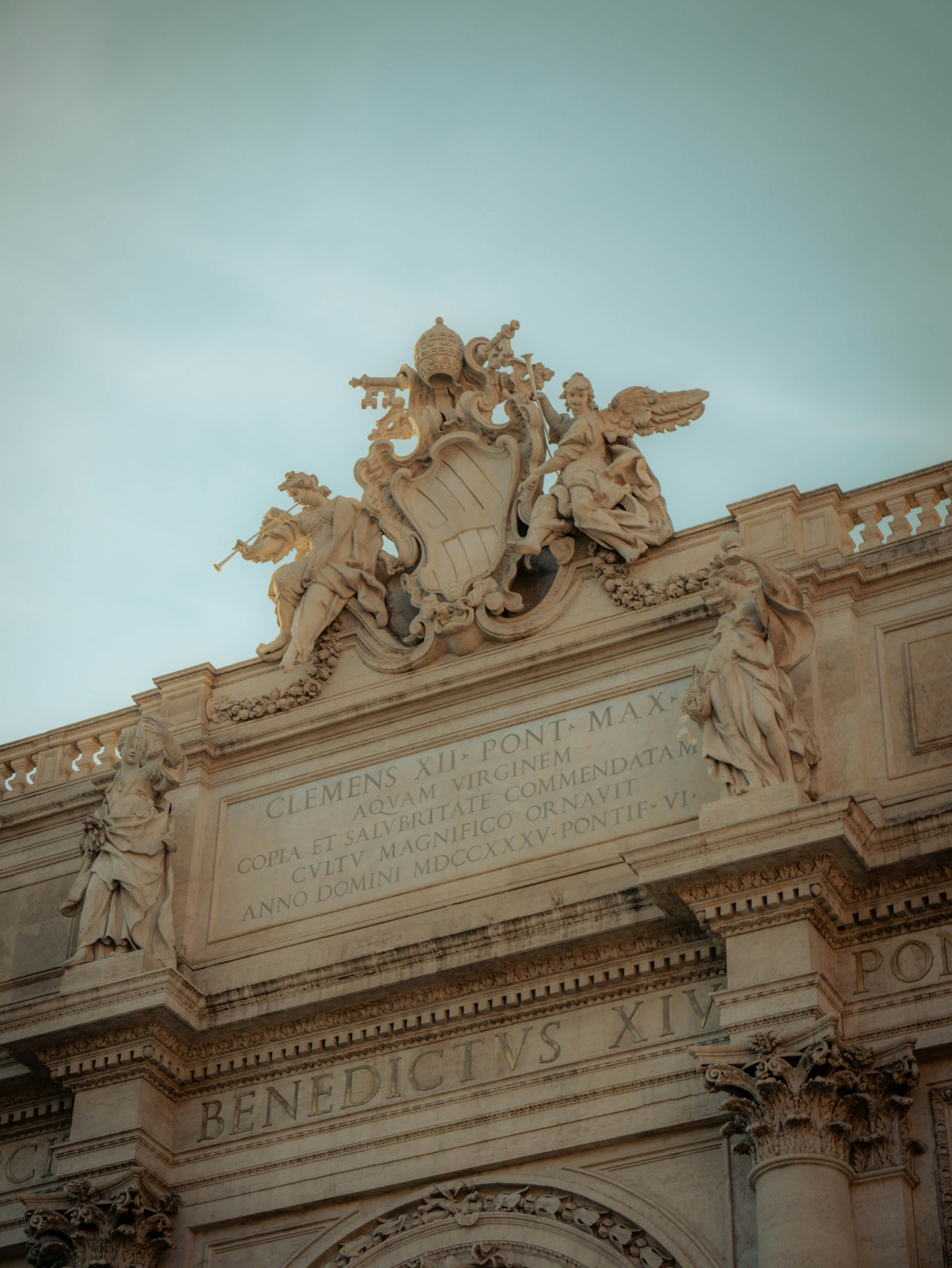 Triumphal Sculpted Crest: Ornate Gateway Crowned by Angelic Figures