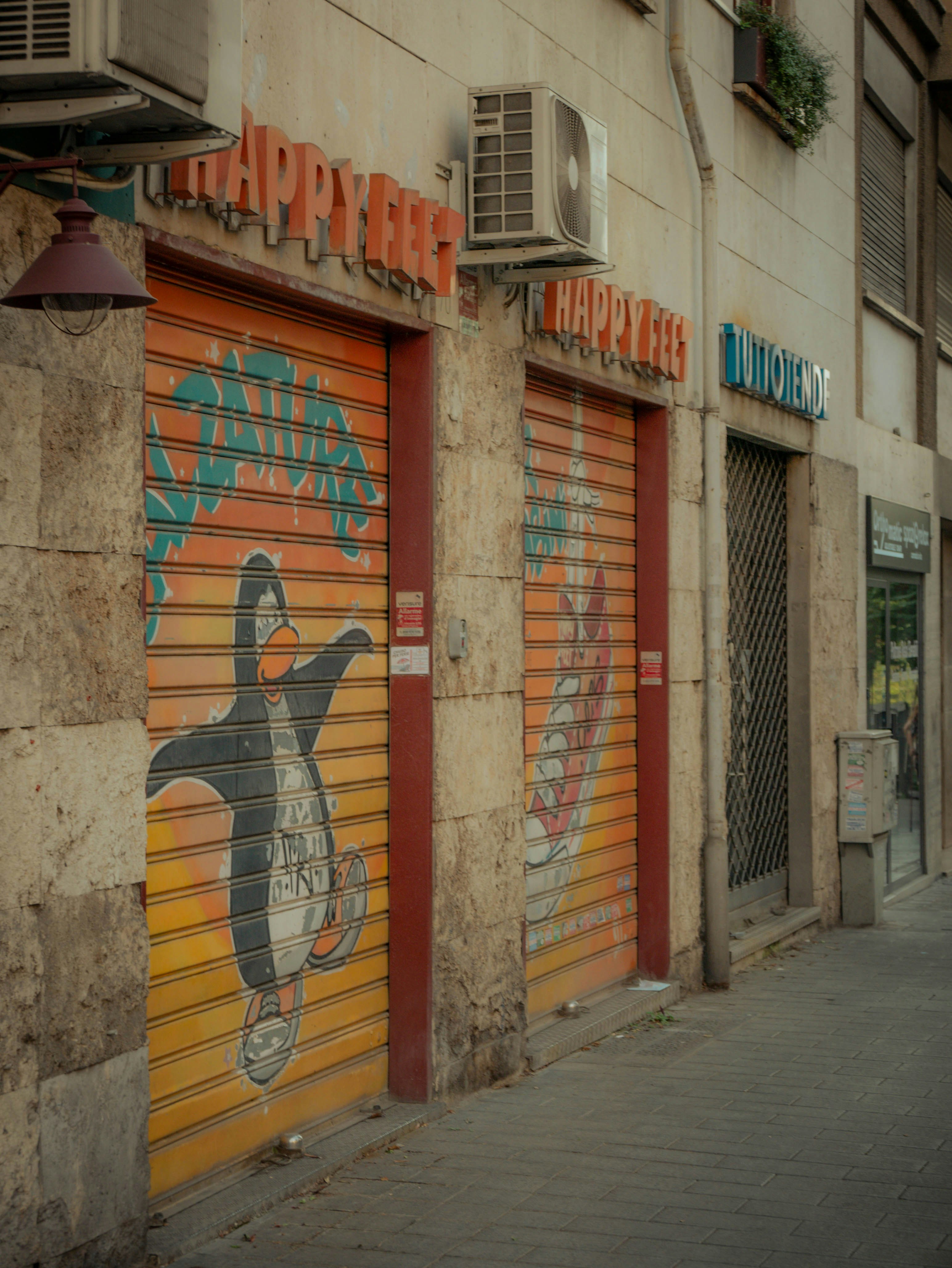 Graffiti-Stamped Storefronts on a Quiet Mediterranean Street