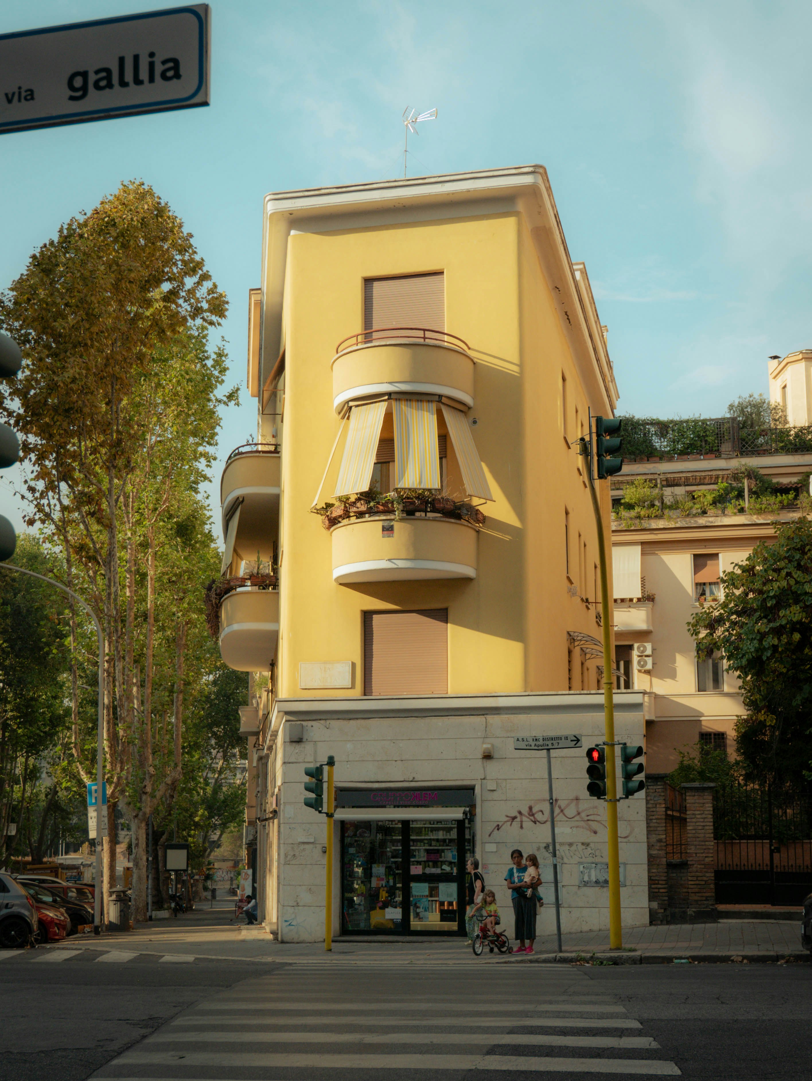 Sunlit Yellow Corner: A Stoic Building and Street Corner