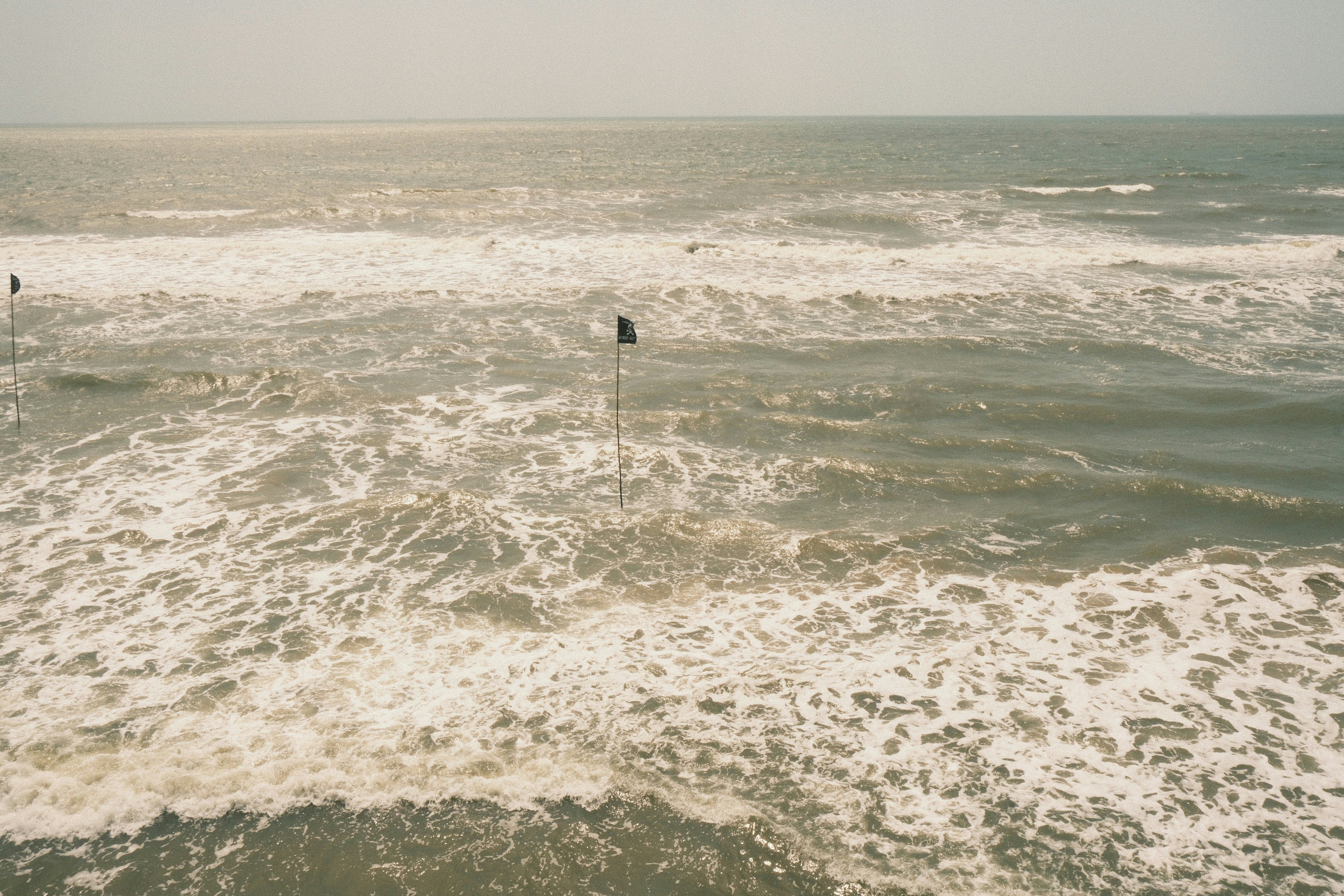 Flags Above the Tides: A Seascape in Gentle Wind