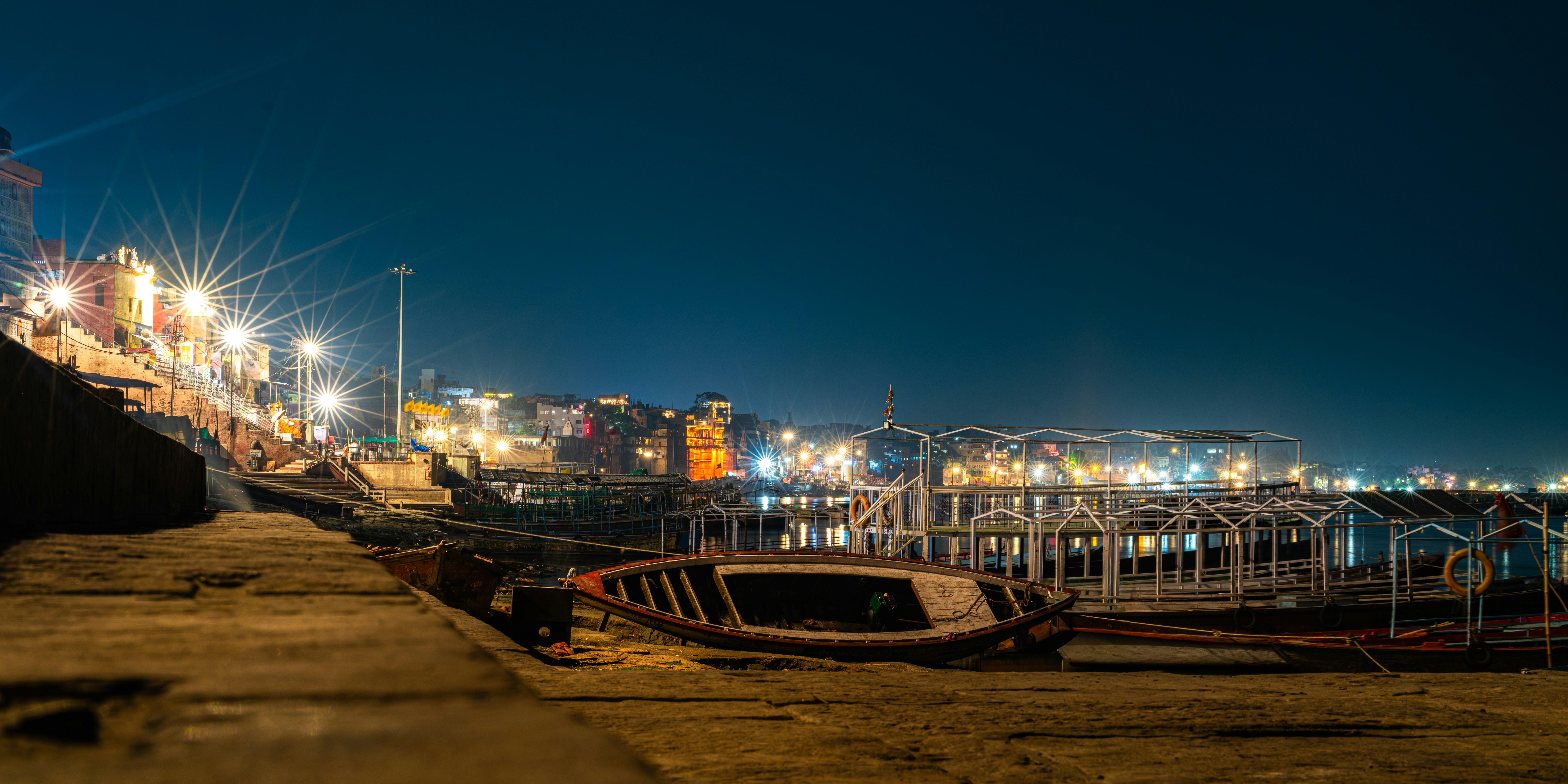 Night Harbor Lights: Boats, Docks, and a Starry Industrial Skyline