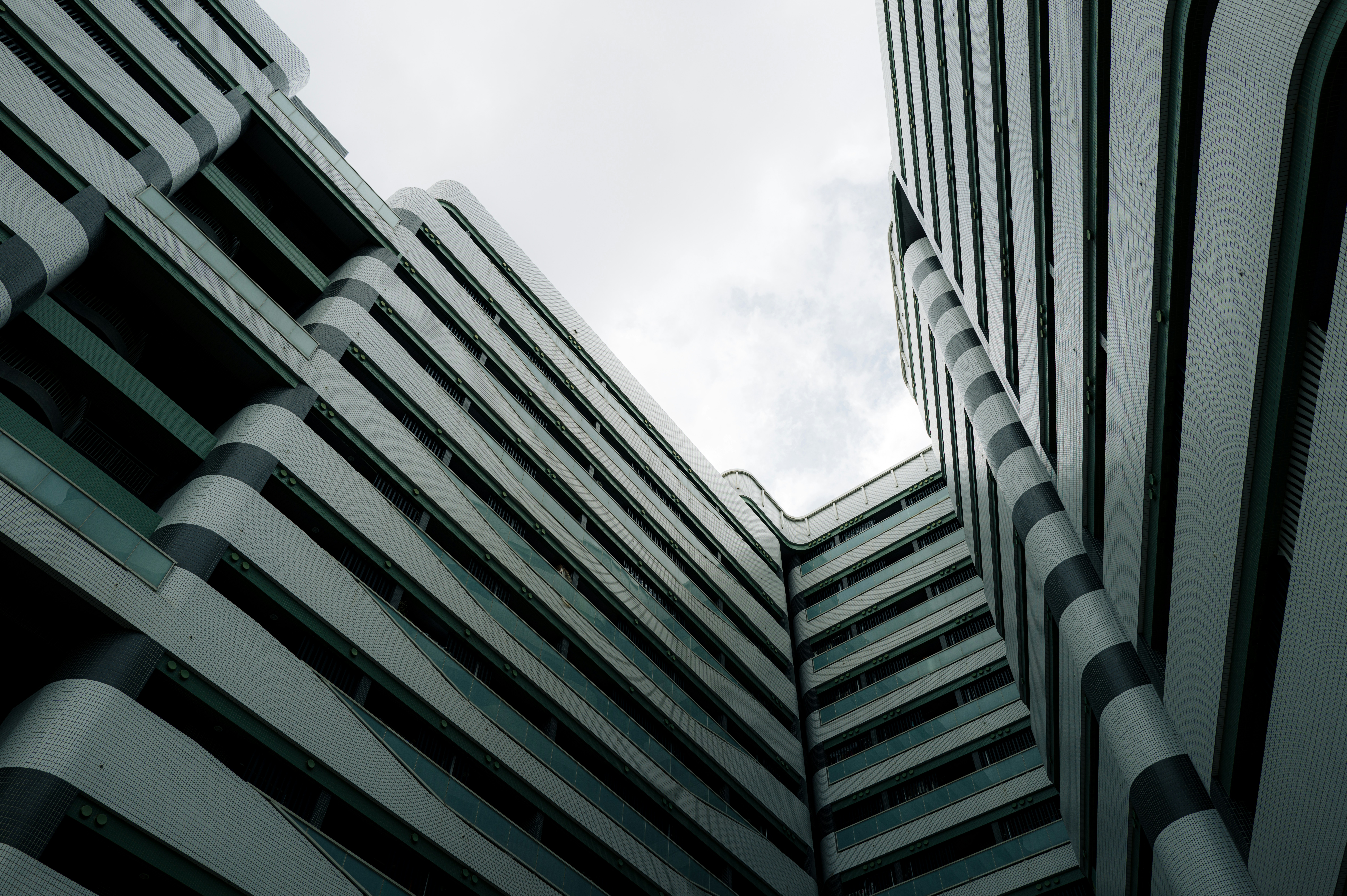 Modern building with curved balconies against a cloudy sky photo – Free ...