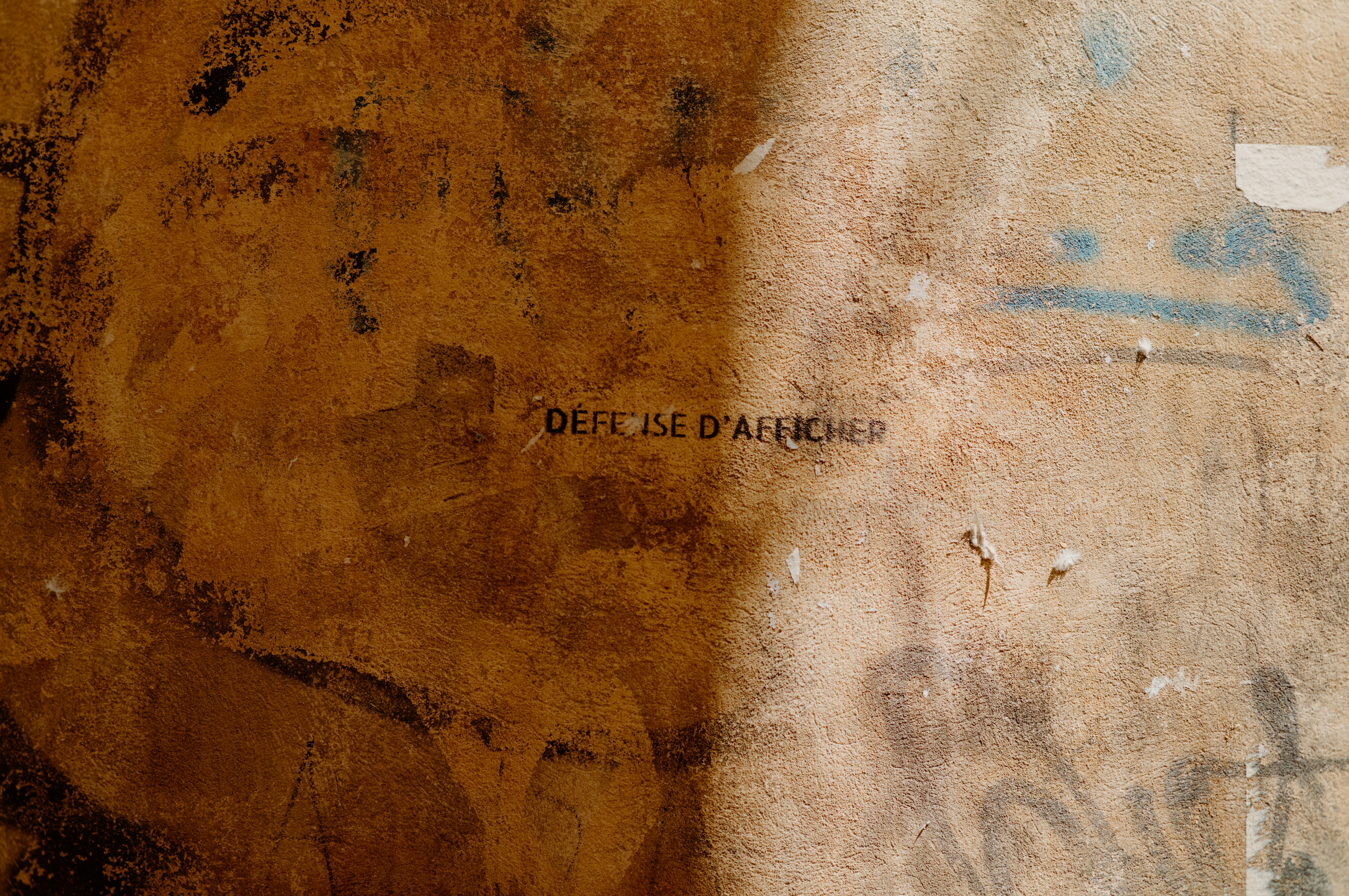 Weathered Graffiti Portrait: A Quiet Corner in Rust and Ink