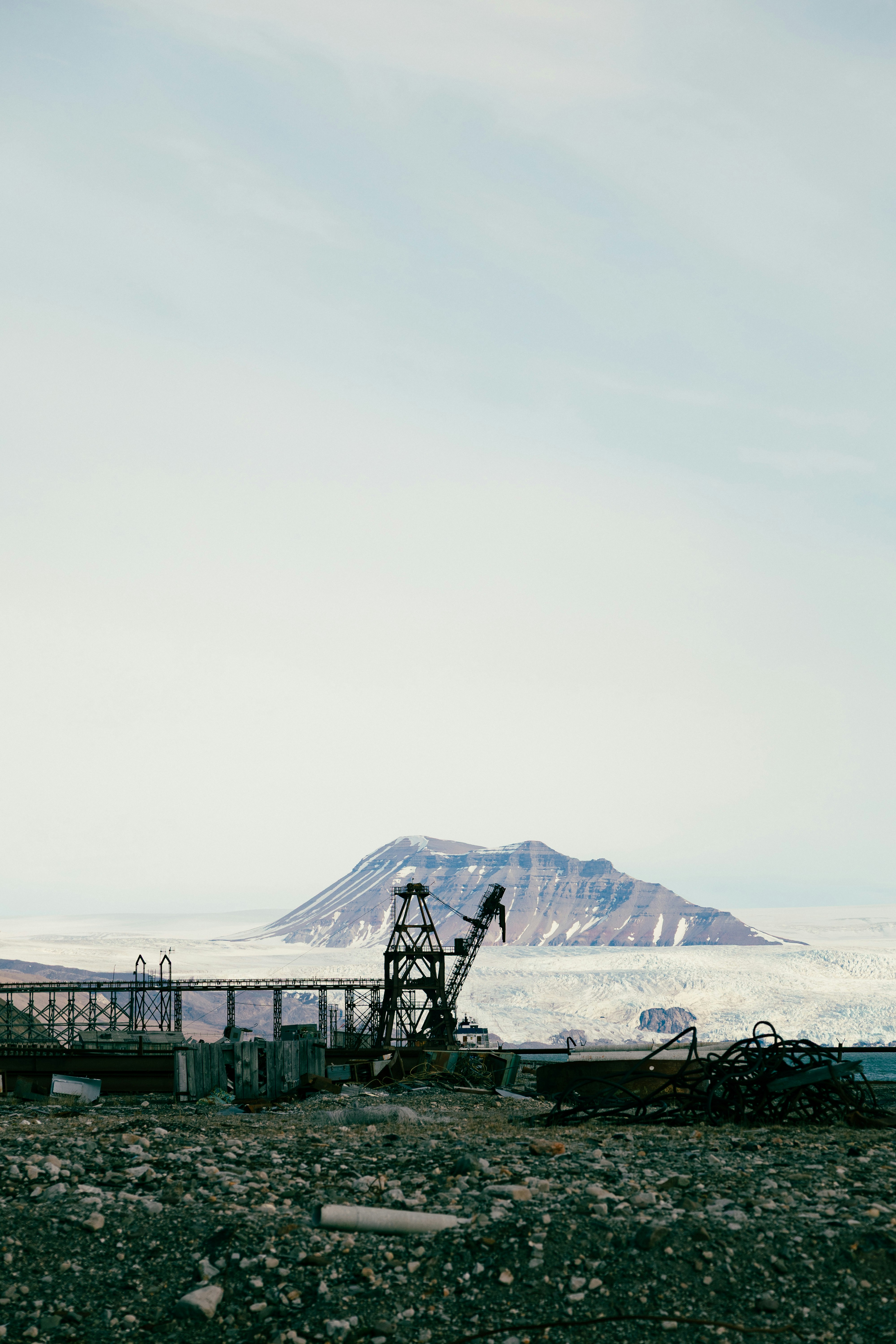 Harvesters at the Ice Edge: Machinery Silhouetted Against a Polar Landscape