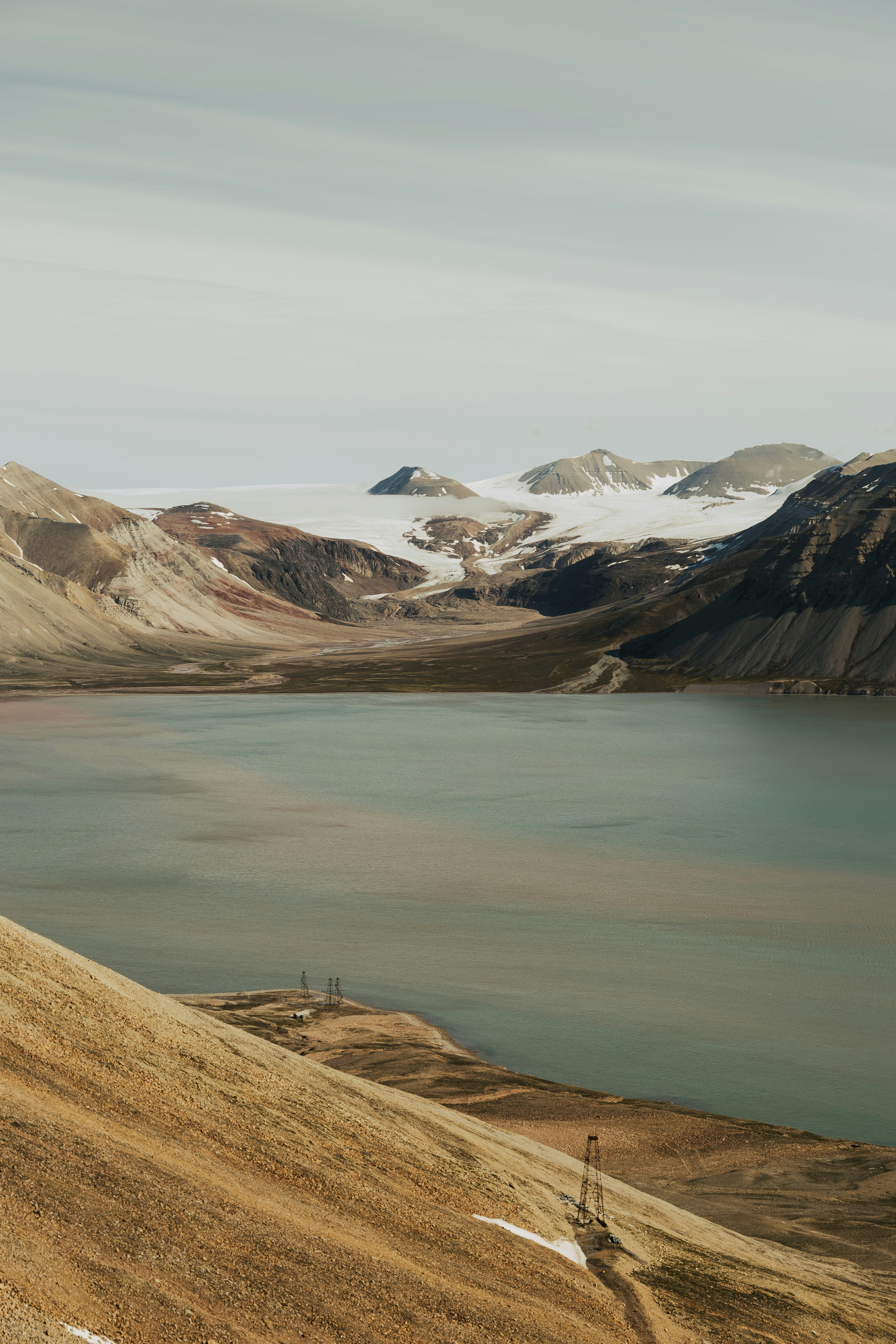 Silent Fjord: Snow-Dusted Peaks Over Turquoise Glacial Water