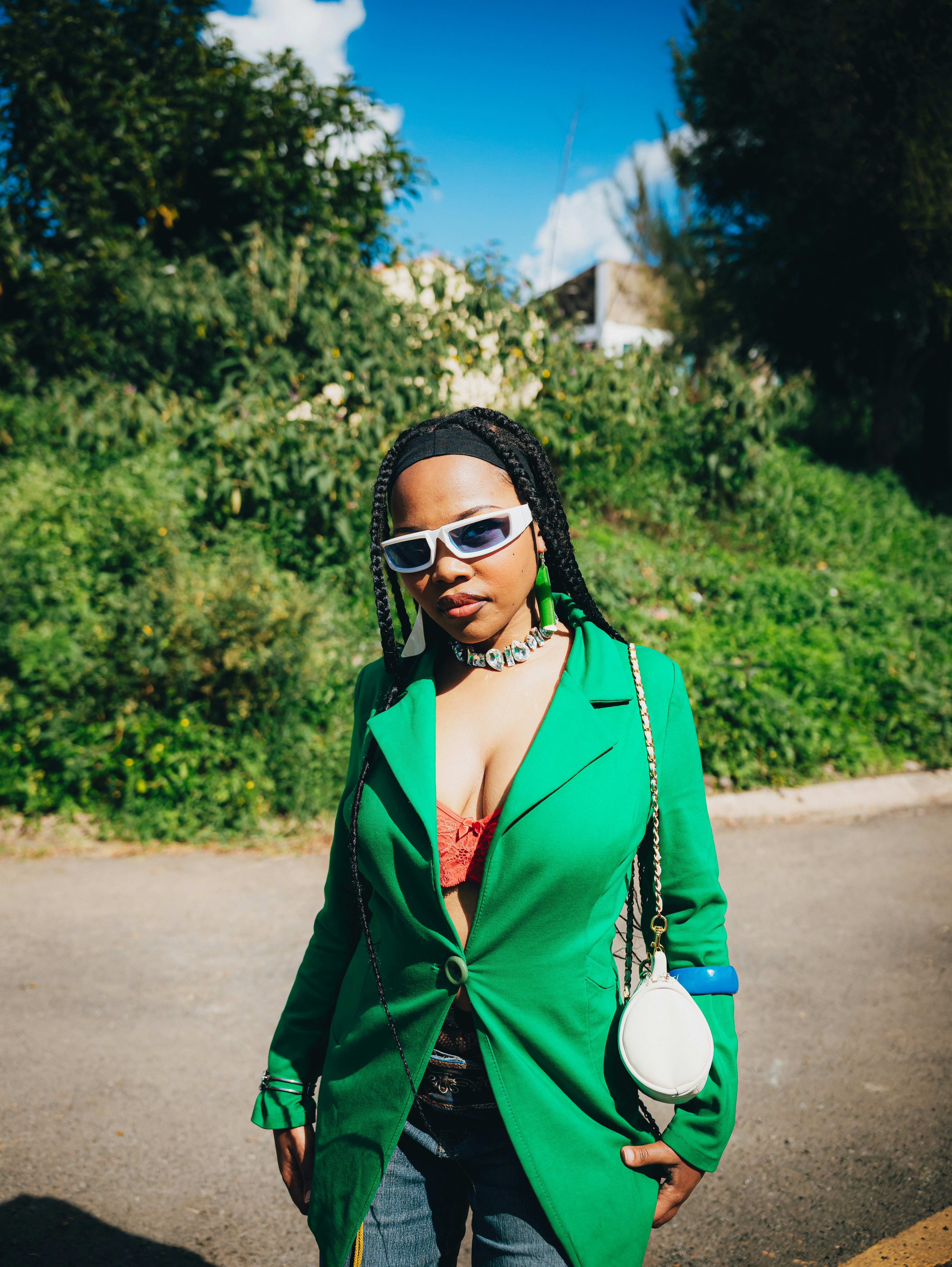 Green blazer, bold stance: a street-ready portrait with neon accents