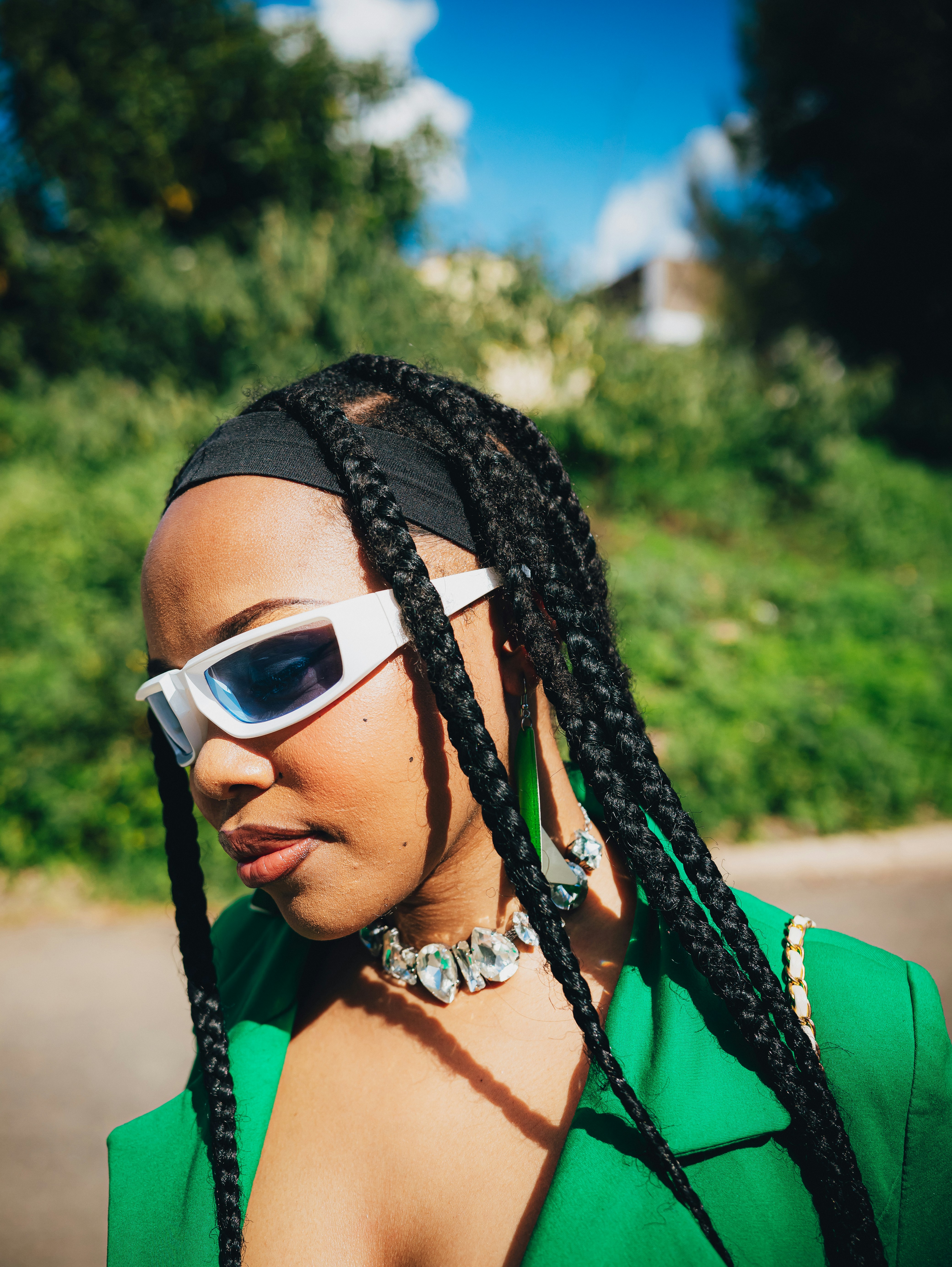 Neon-green blazer and braids under outdoor sun
