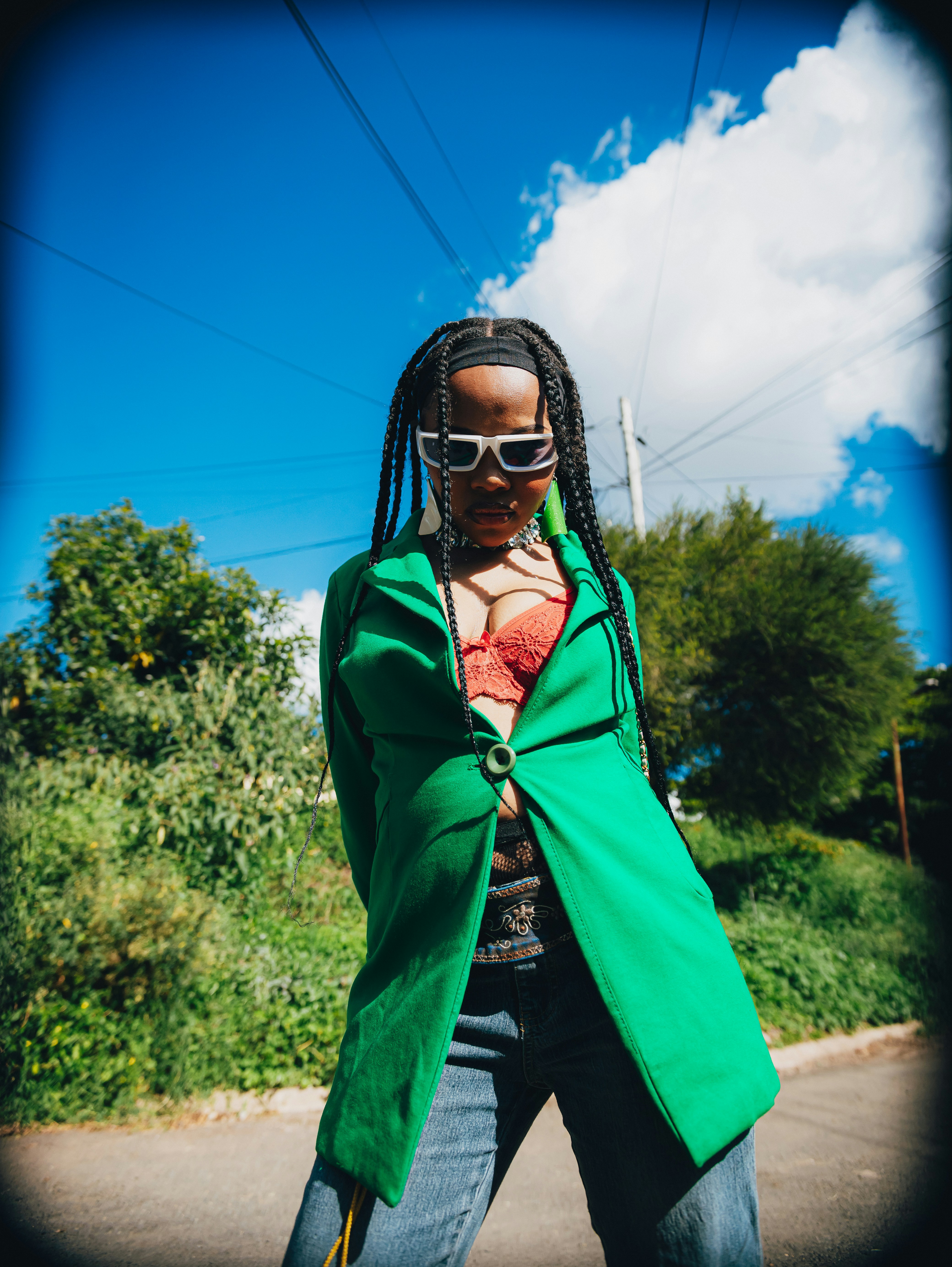 Vibrant Green Coat Under Bright Blue Sky