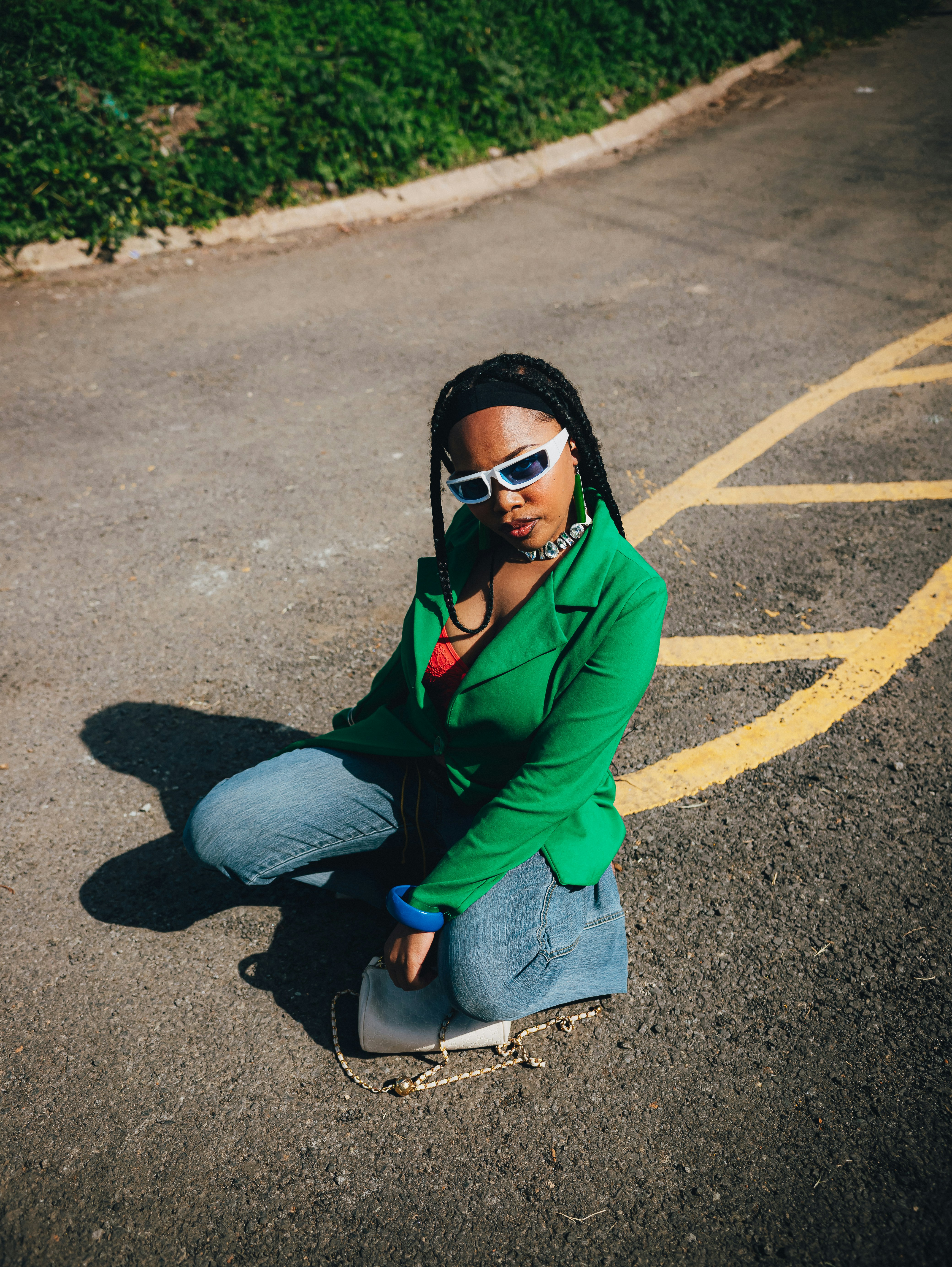 Green blazer, bold stance: a confident portrait in the parking lot