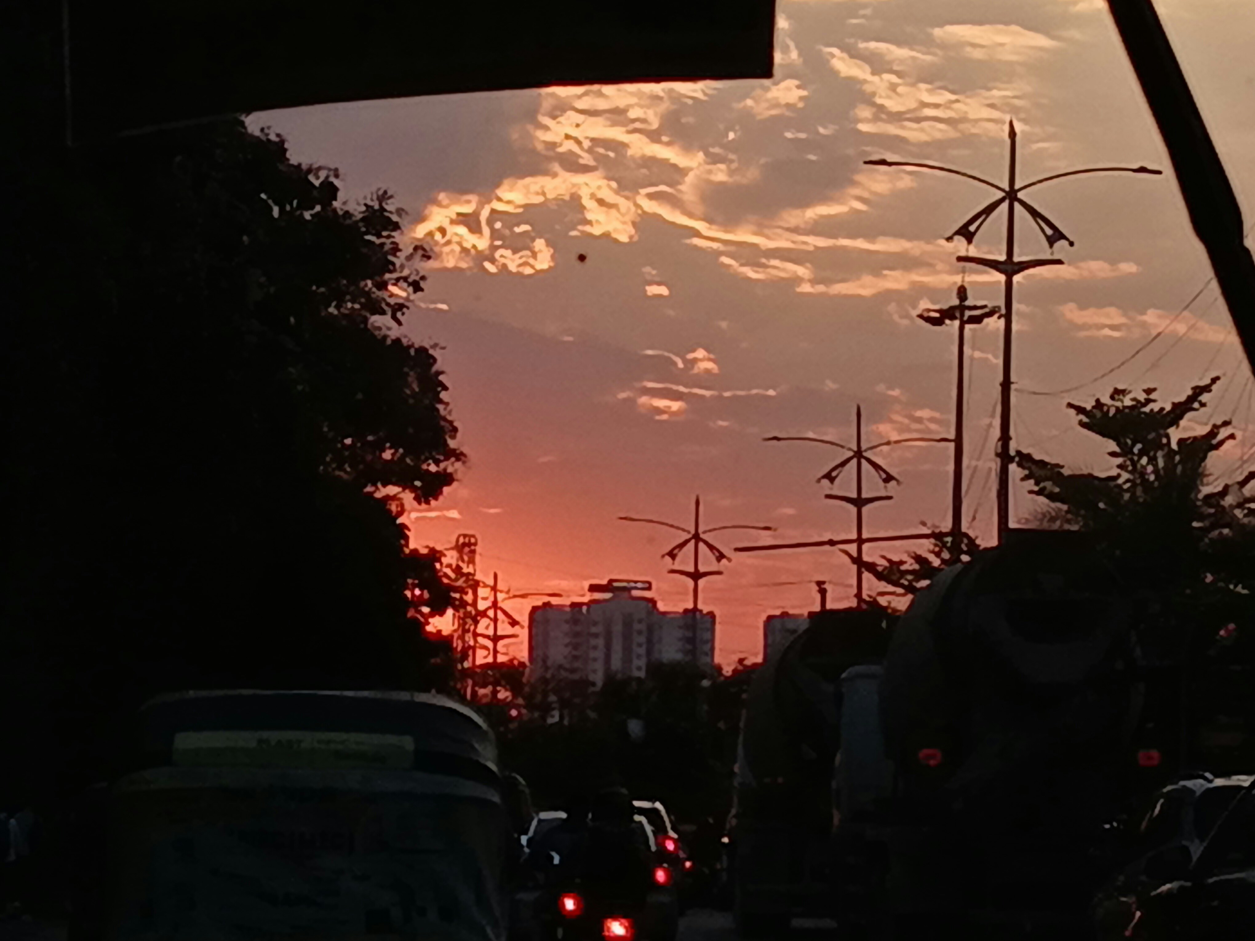 Sunset Rush Through the City: silhouettes and red rails