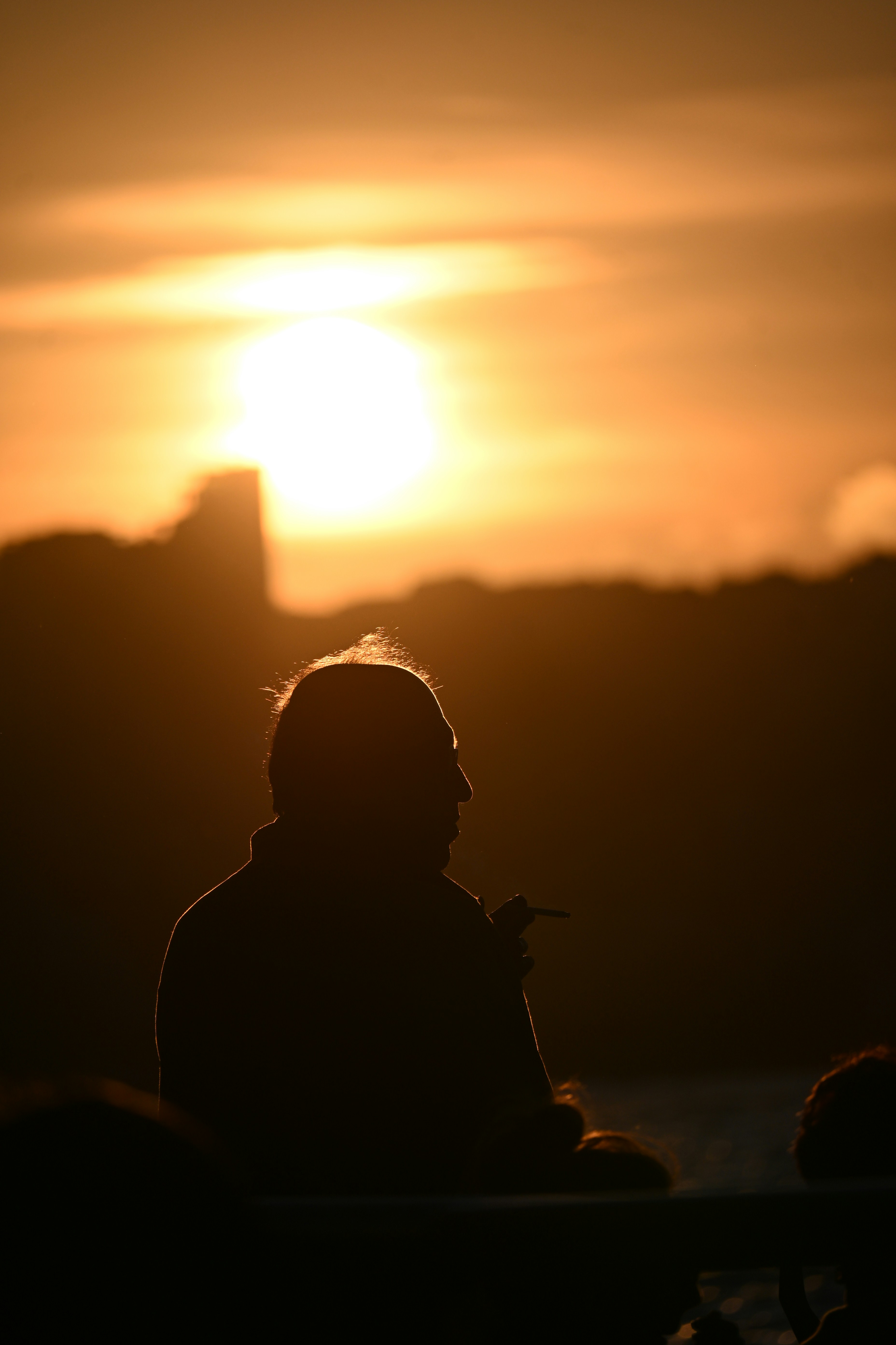 Silhouette at Sunset: A Quiet Moment Against a Golden Horizon