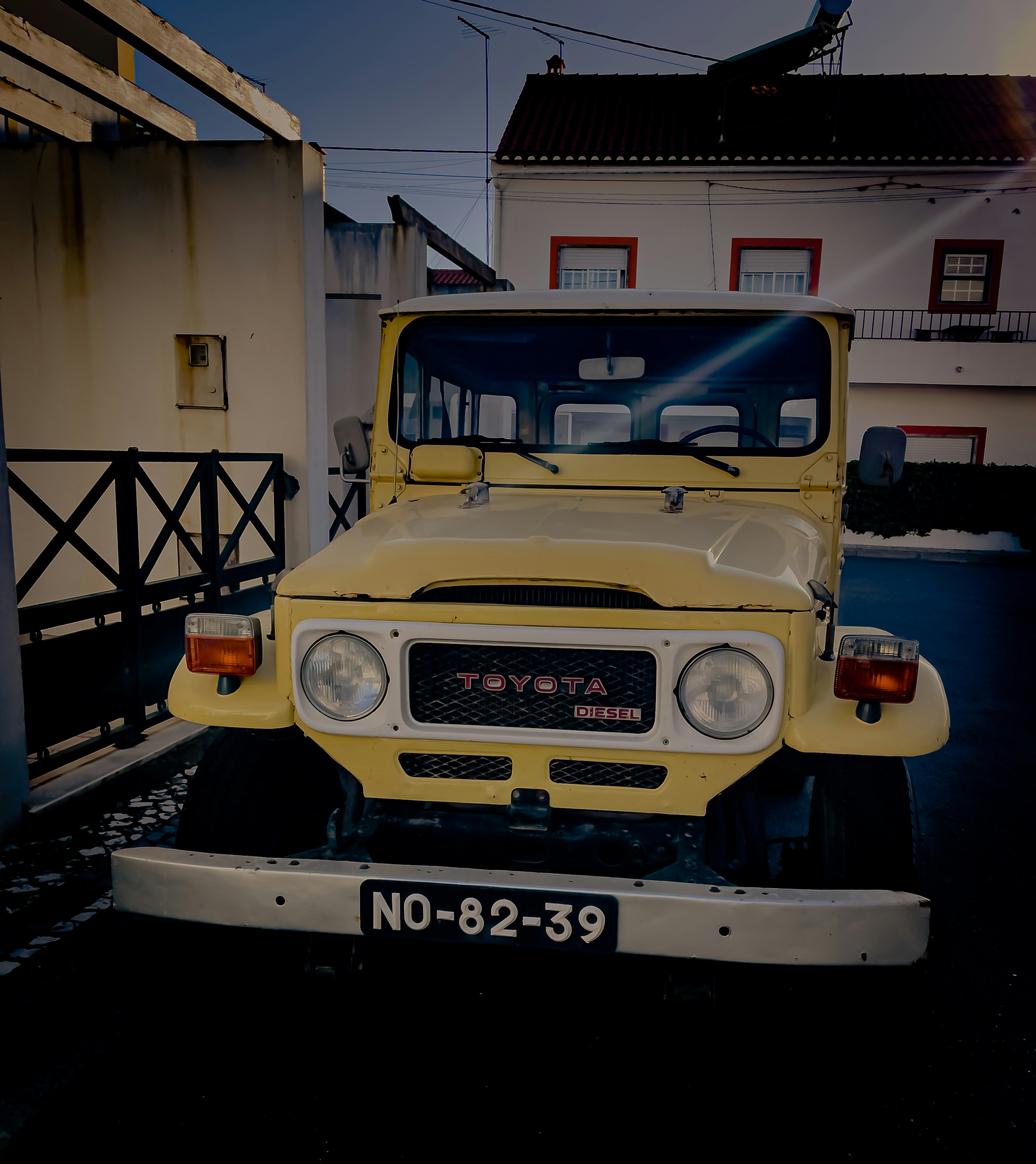 Yellow Toyota Truck Facing the Street at Dusk