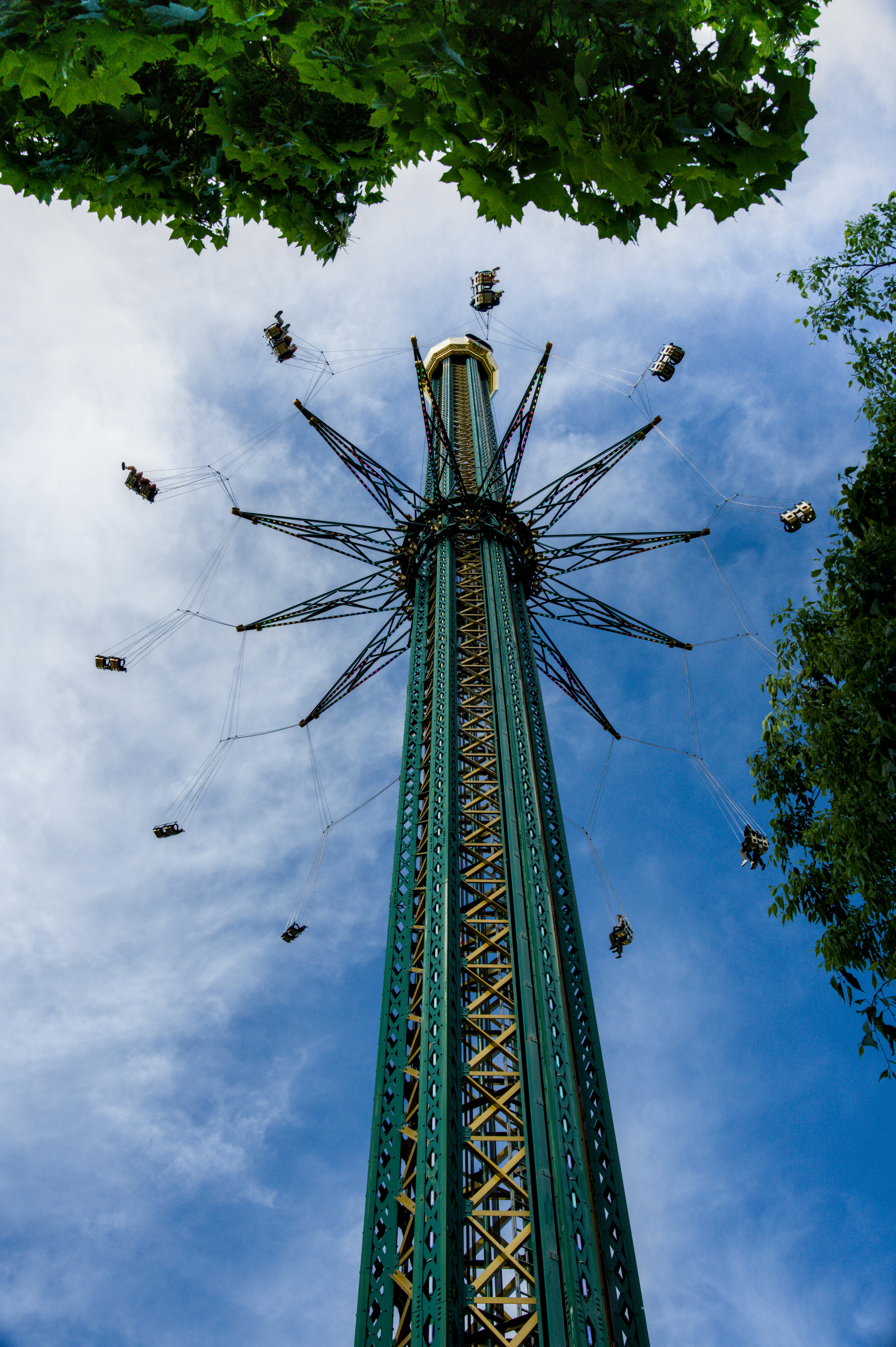 Skyward Orbit: Riders at the Top of a Tower Ride