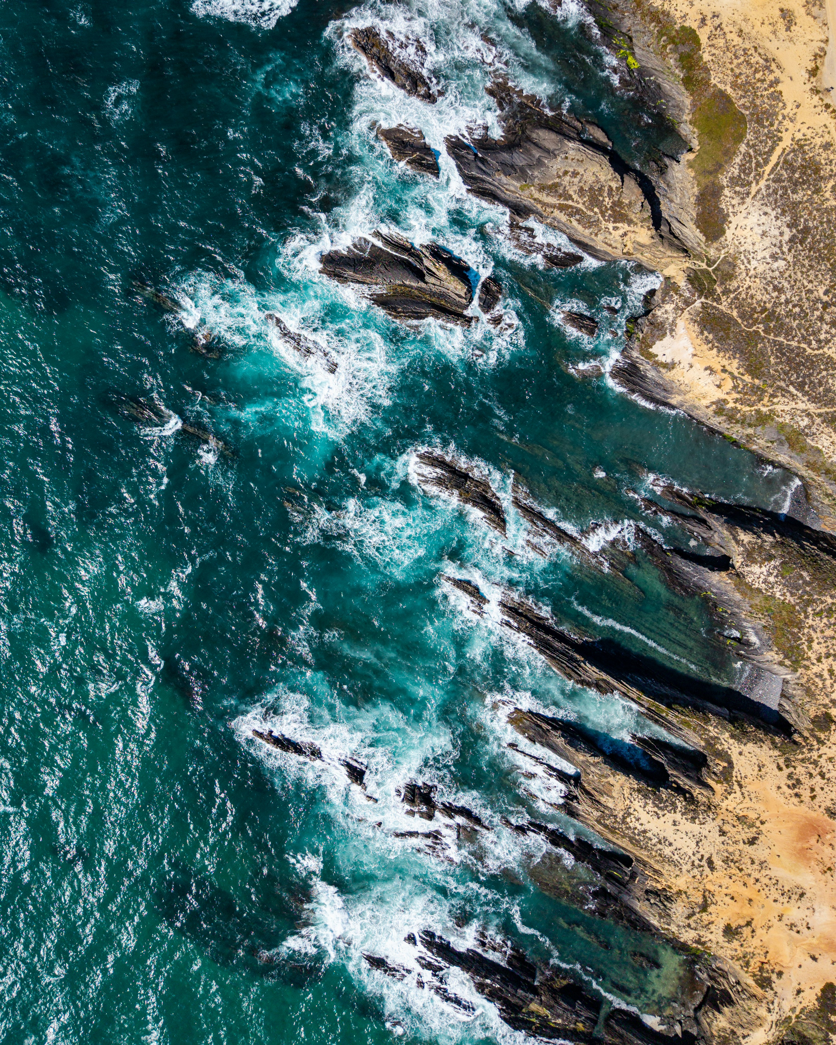 Emerald Currents Along Rugged Coastline