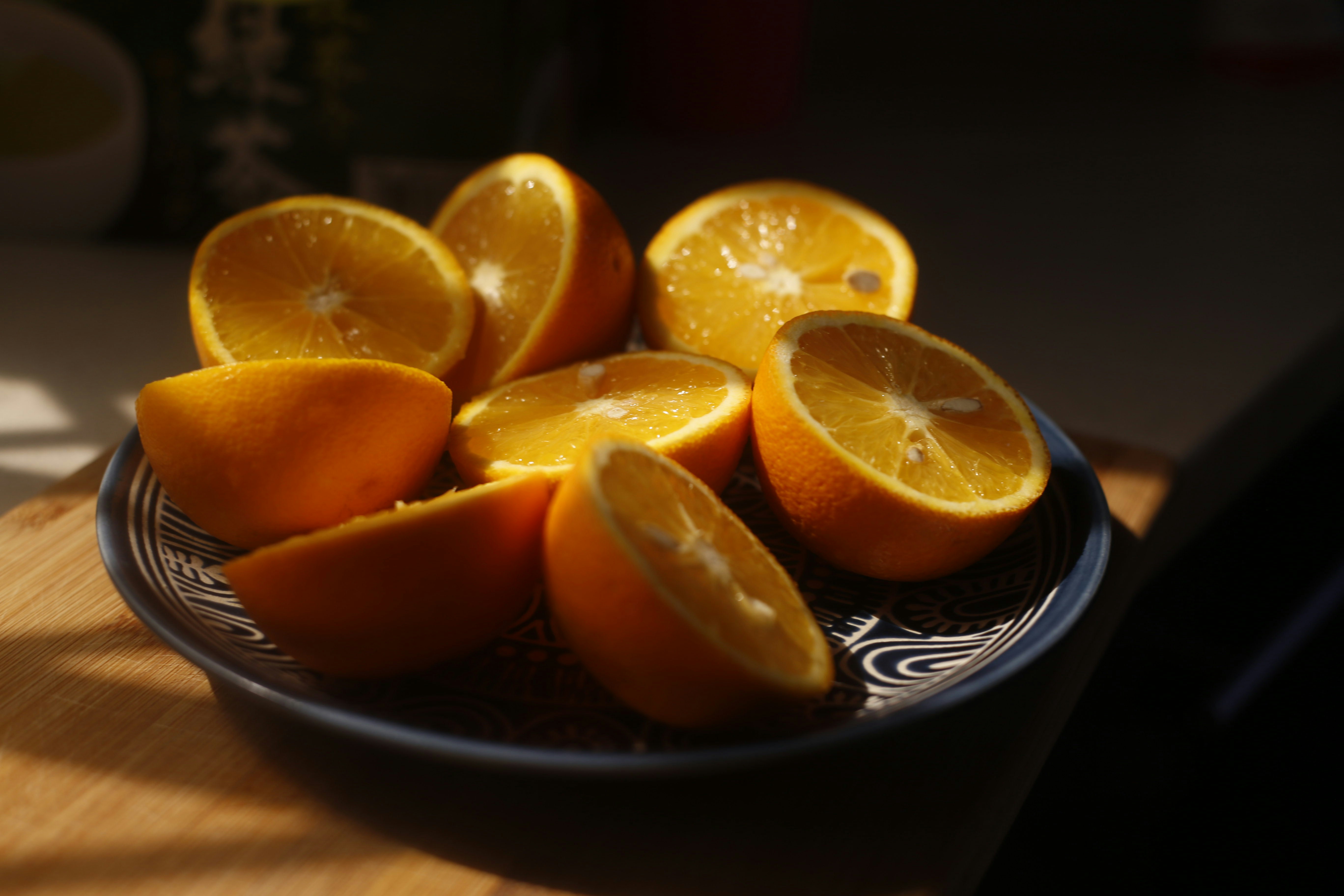 Citrus Spotlight: Halved Oranges Gathered in a Shaded Bowl