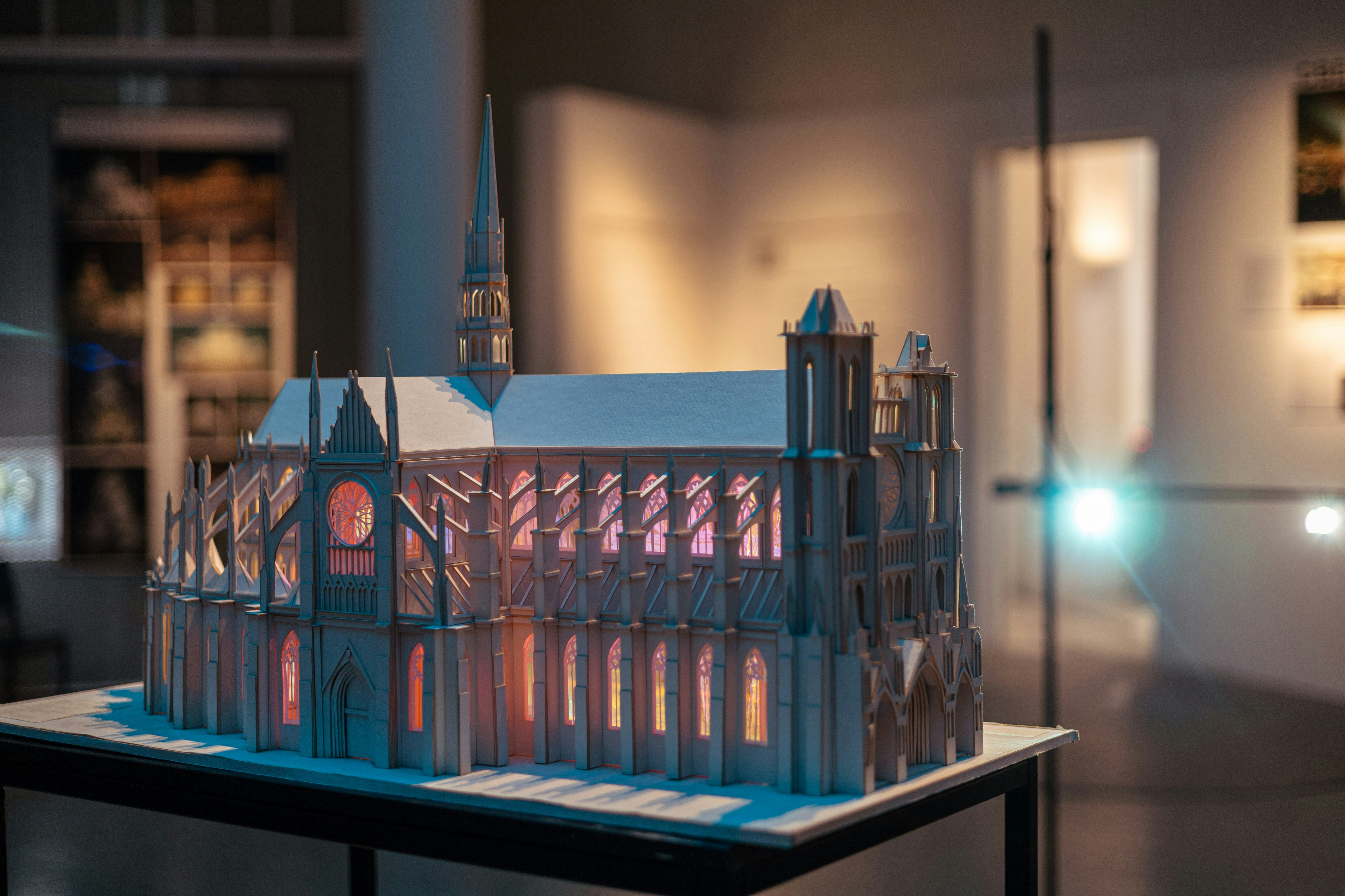Gothic Cathedral Model on Display: Night Exhibit with Soft Blue Illumination