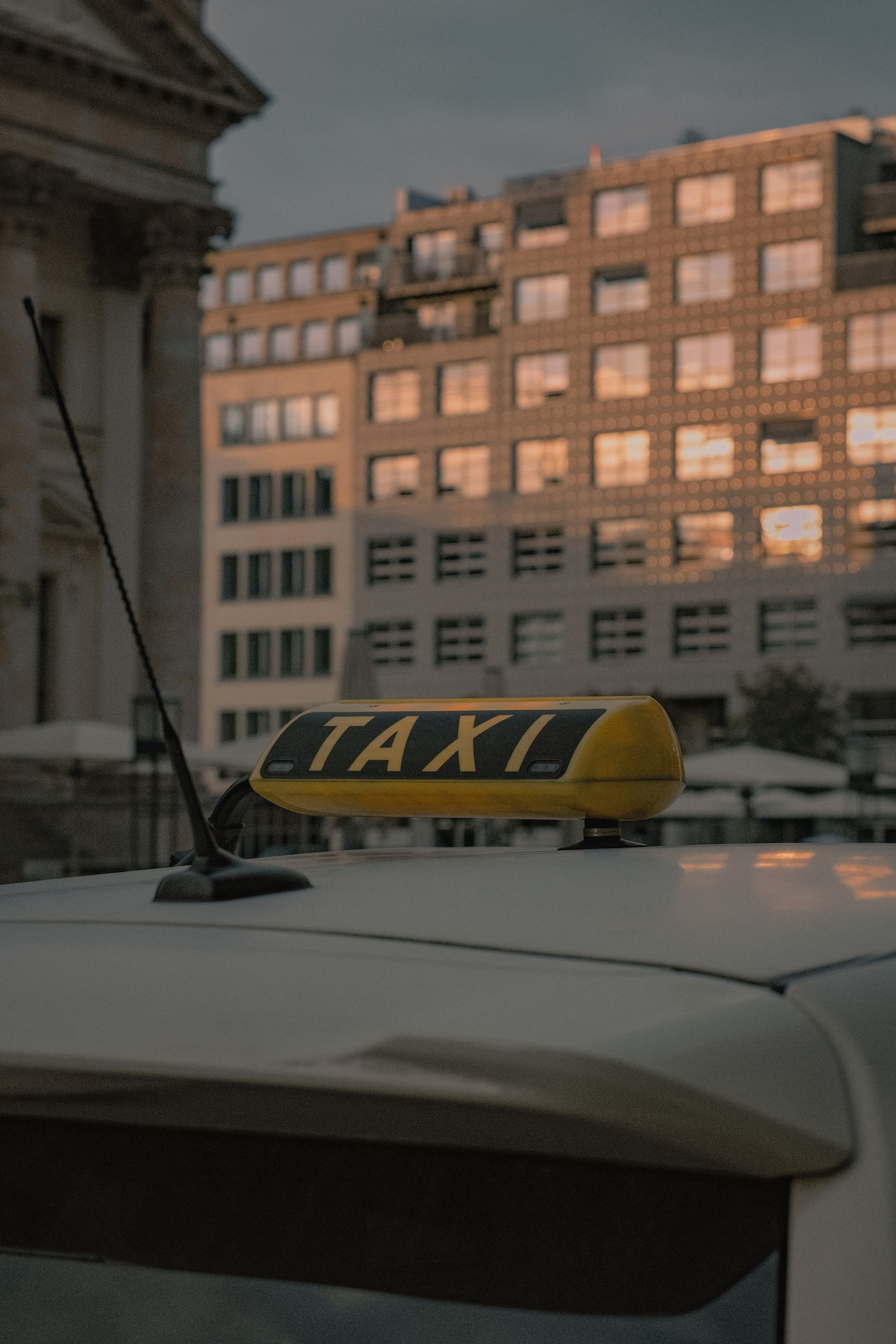 The City Taxi Crown: A Yellow Rooftop Taxi Light Rides Above a Busy Street