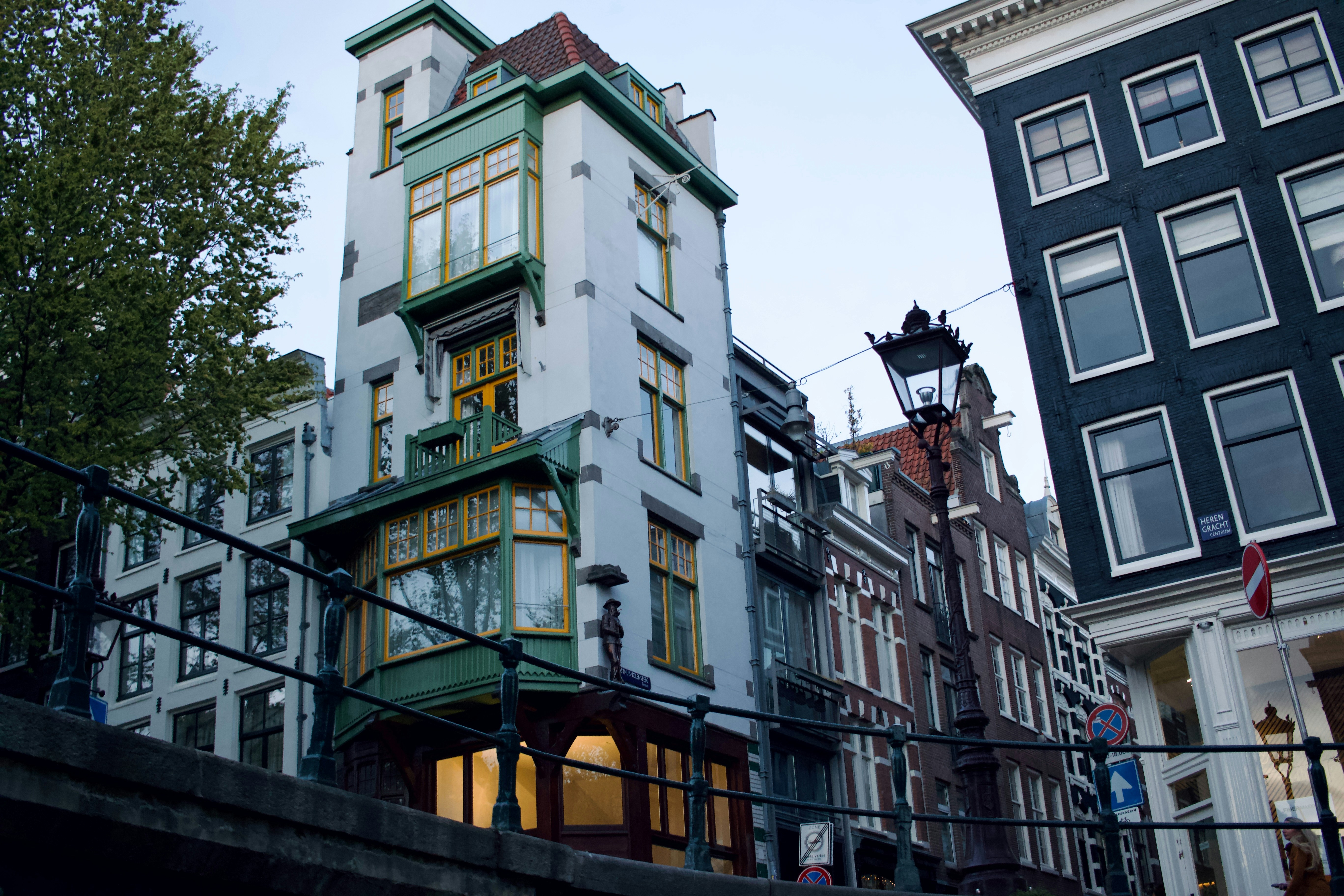 Corner Canal: A Dutch-Style Street Scene with Painted Facades and Street Lamp Echoes