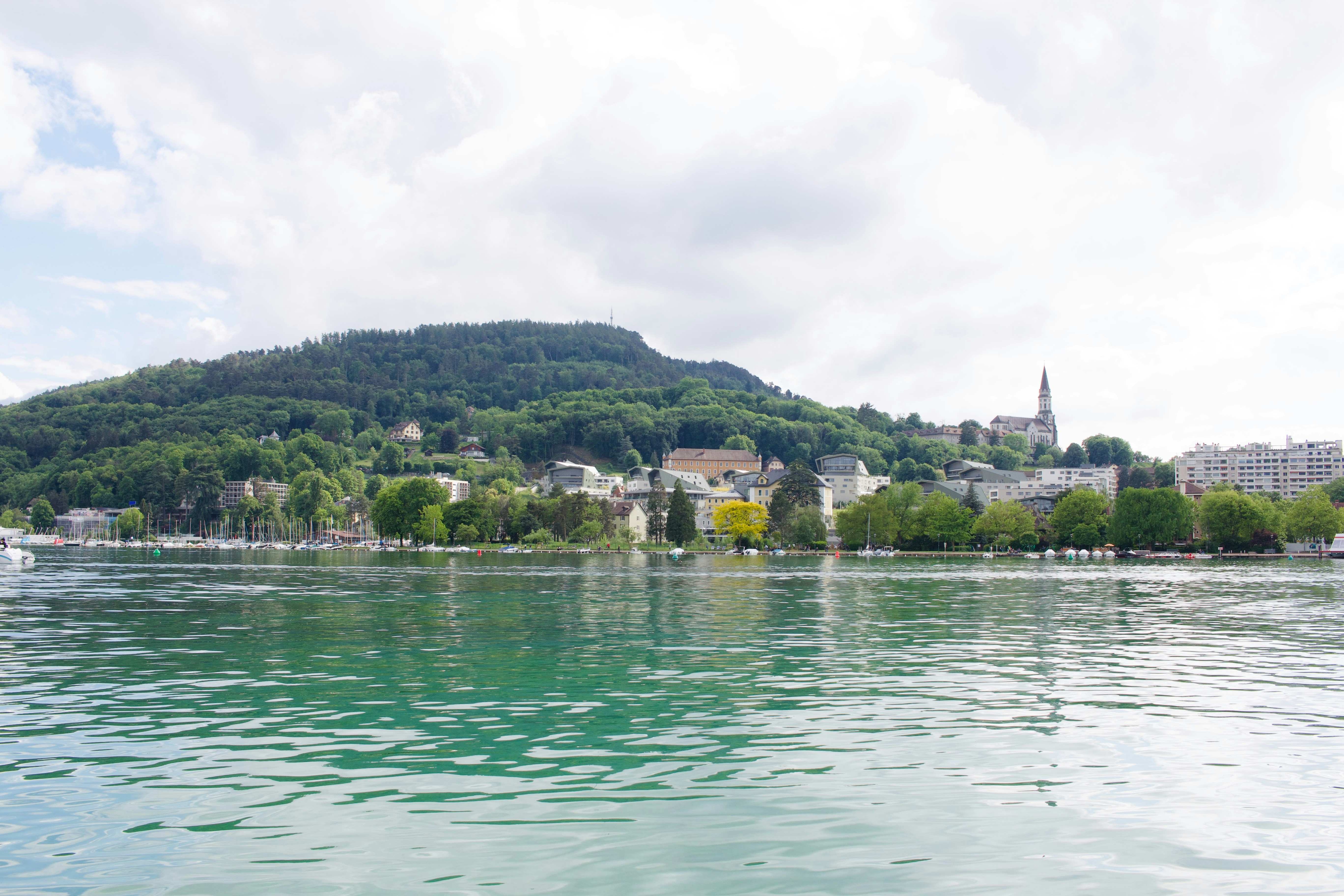 Lakeside Town Rising Beyond Calm Waters