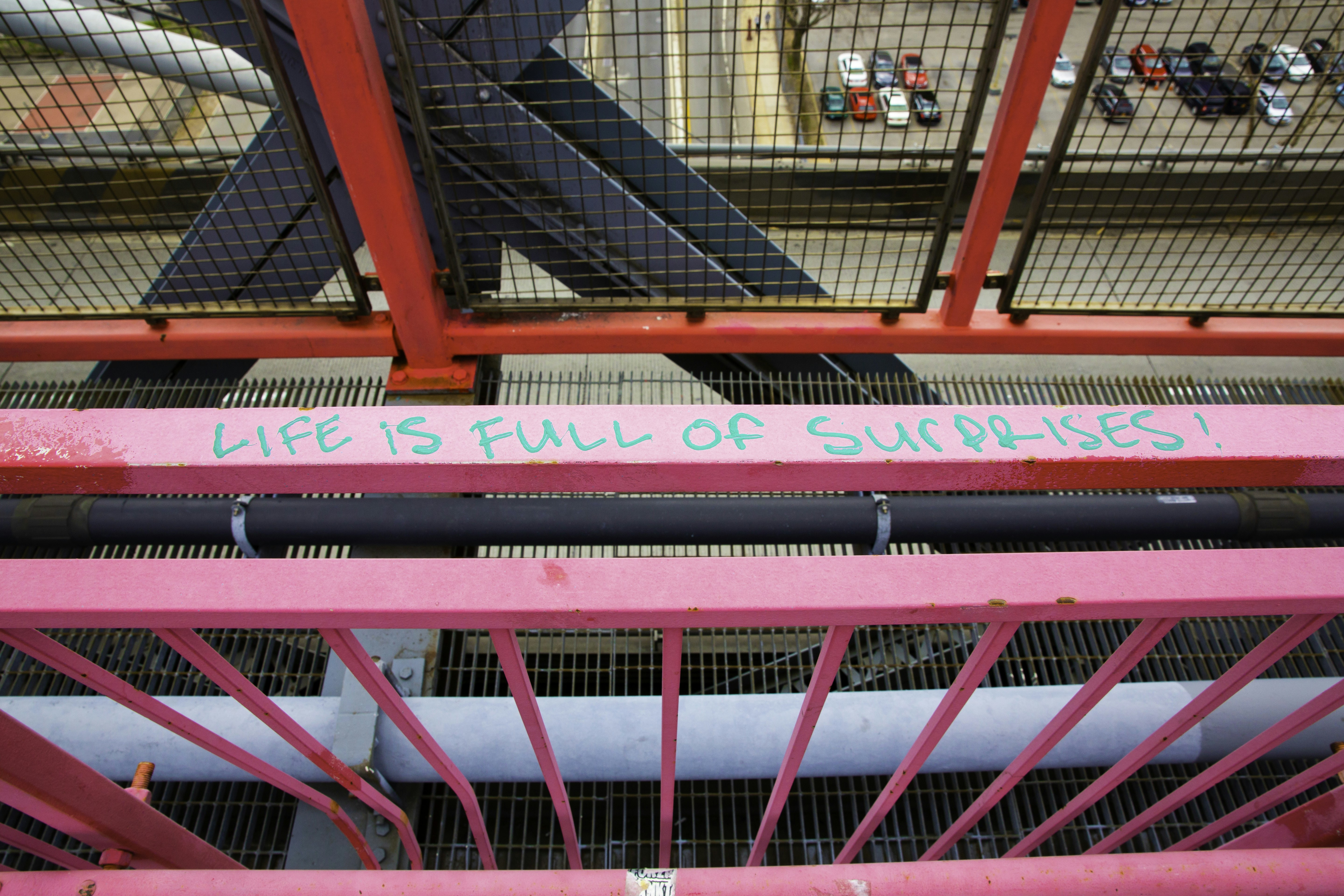 Graffiti Inscribed Rails: Messages Beneath the Pink Framework