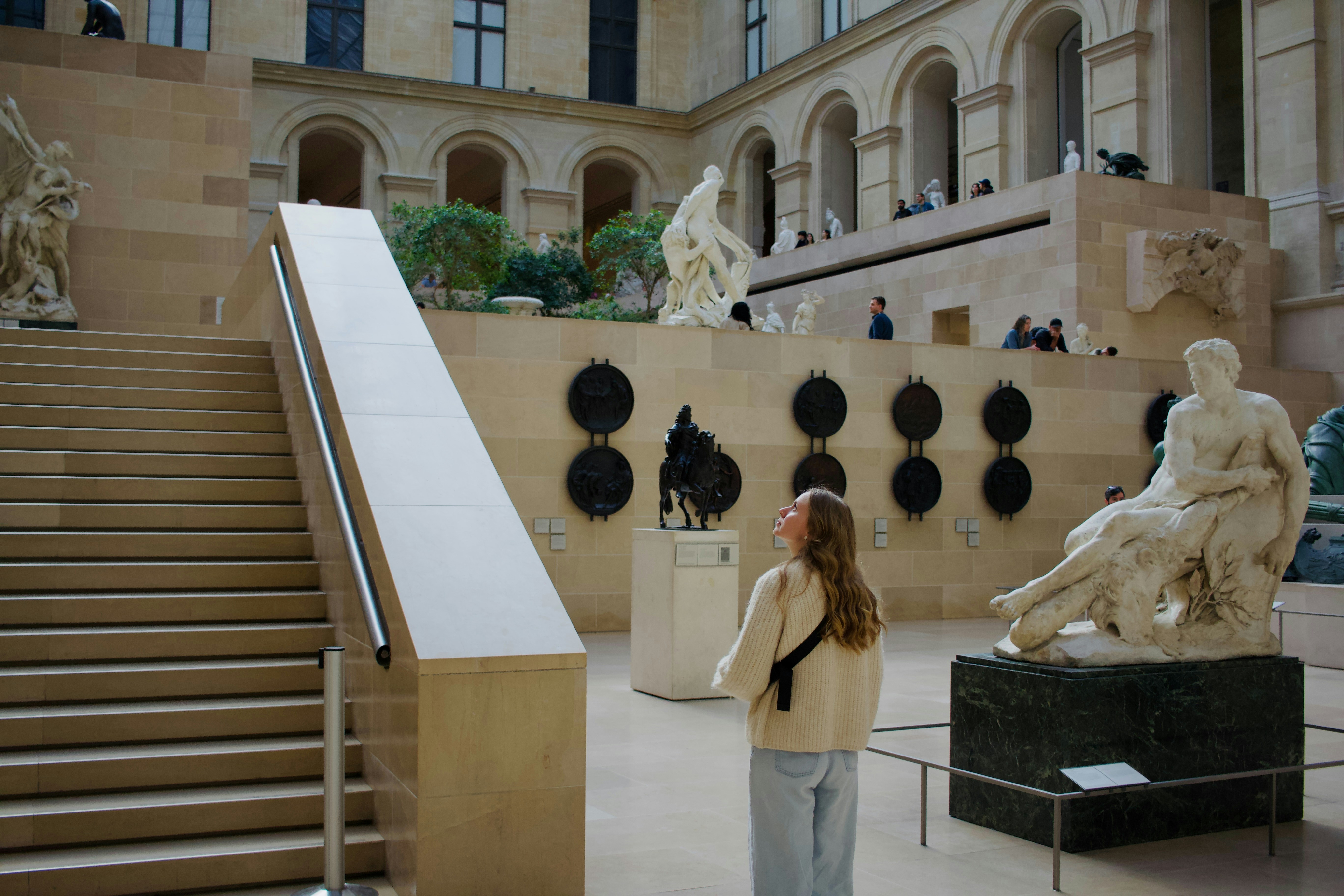 Quiet Curiosity in a Grand Sculpture Gallery
