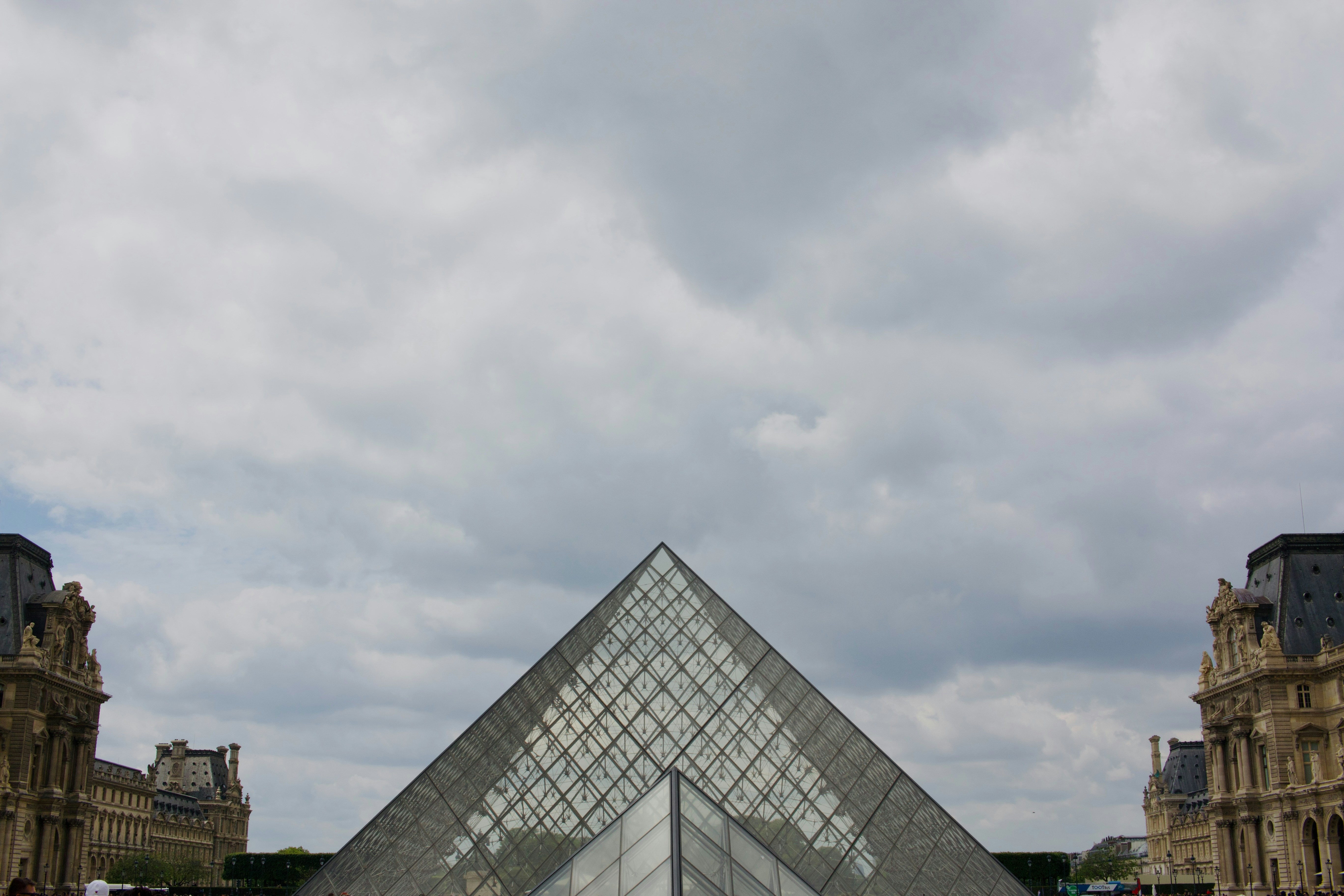 Symmetry Under Glass: The Louvre Pyramid Framed by Historic Wings