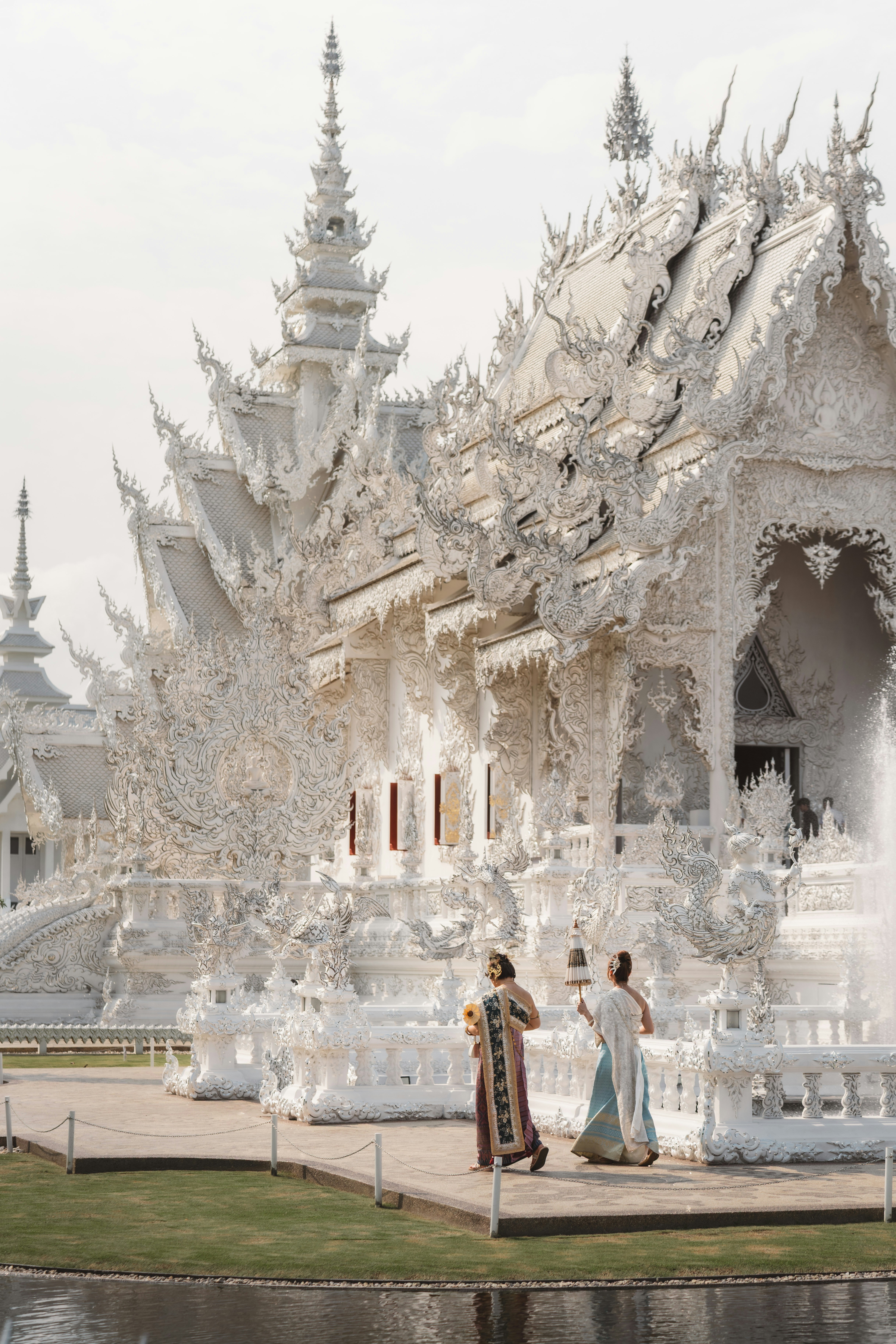 Faces of Serenity Amid White Lace: Monastic Figures at Wat Rongkhun-Inspired Temple