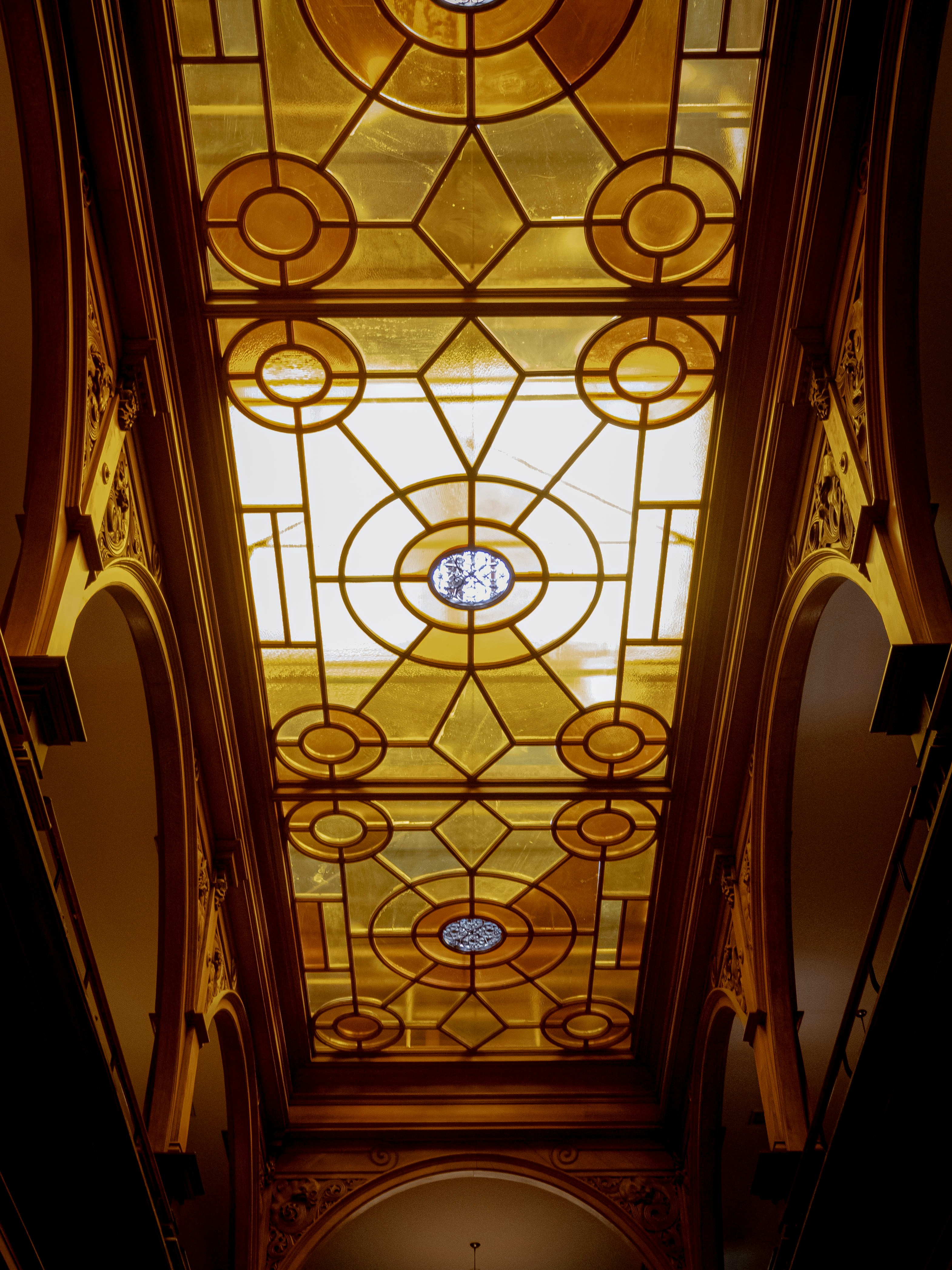 Stained Glass Atrium: Golden Light Through Geometric Circles