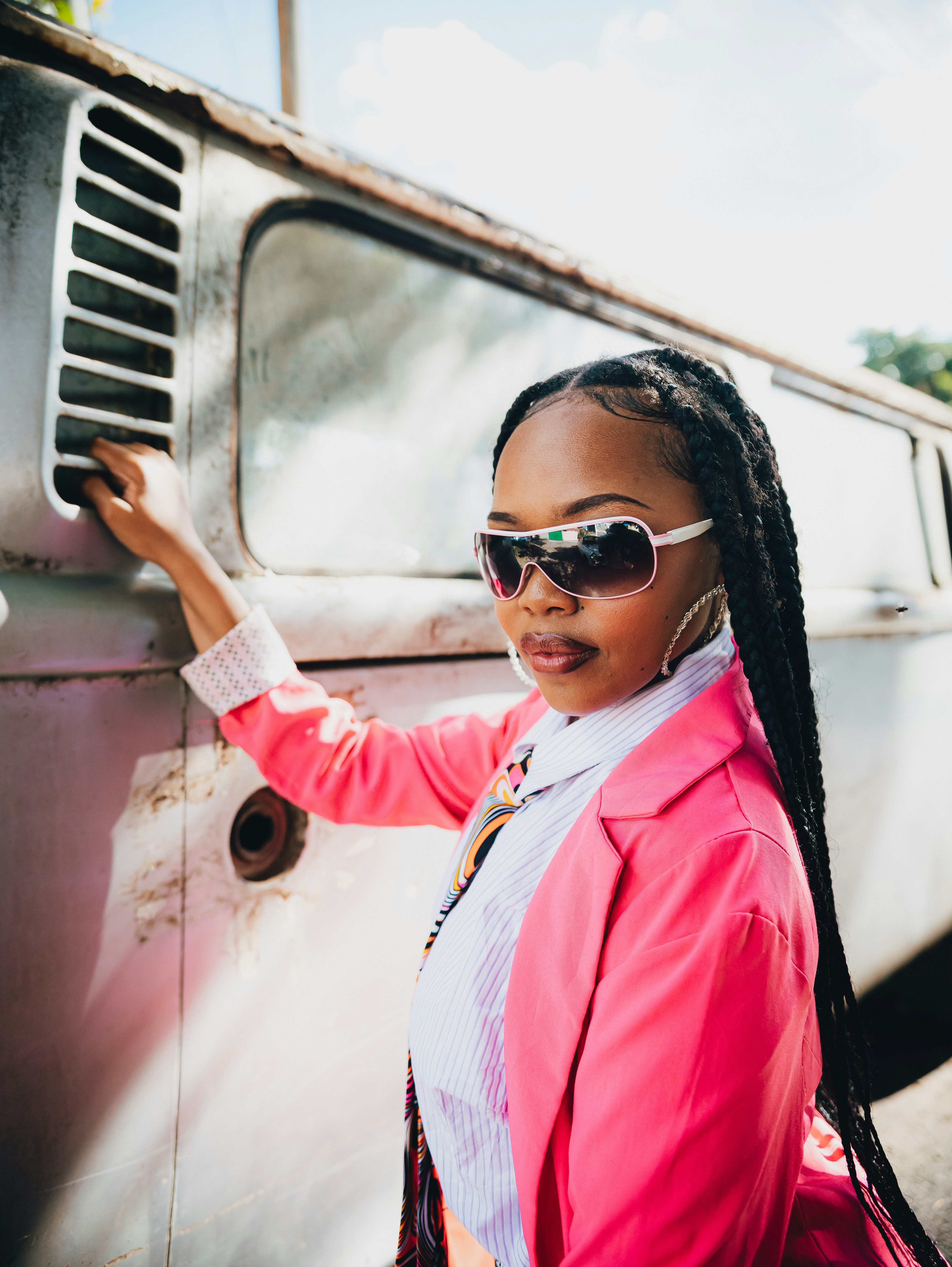 Bold Horizon: A Portrait in Bright Pink Against a Weathered Ride