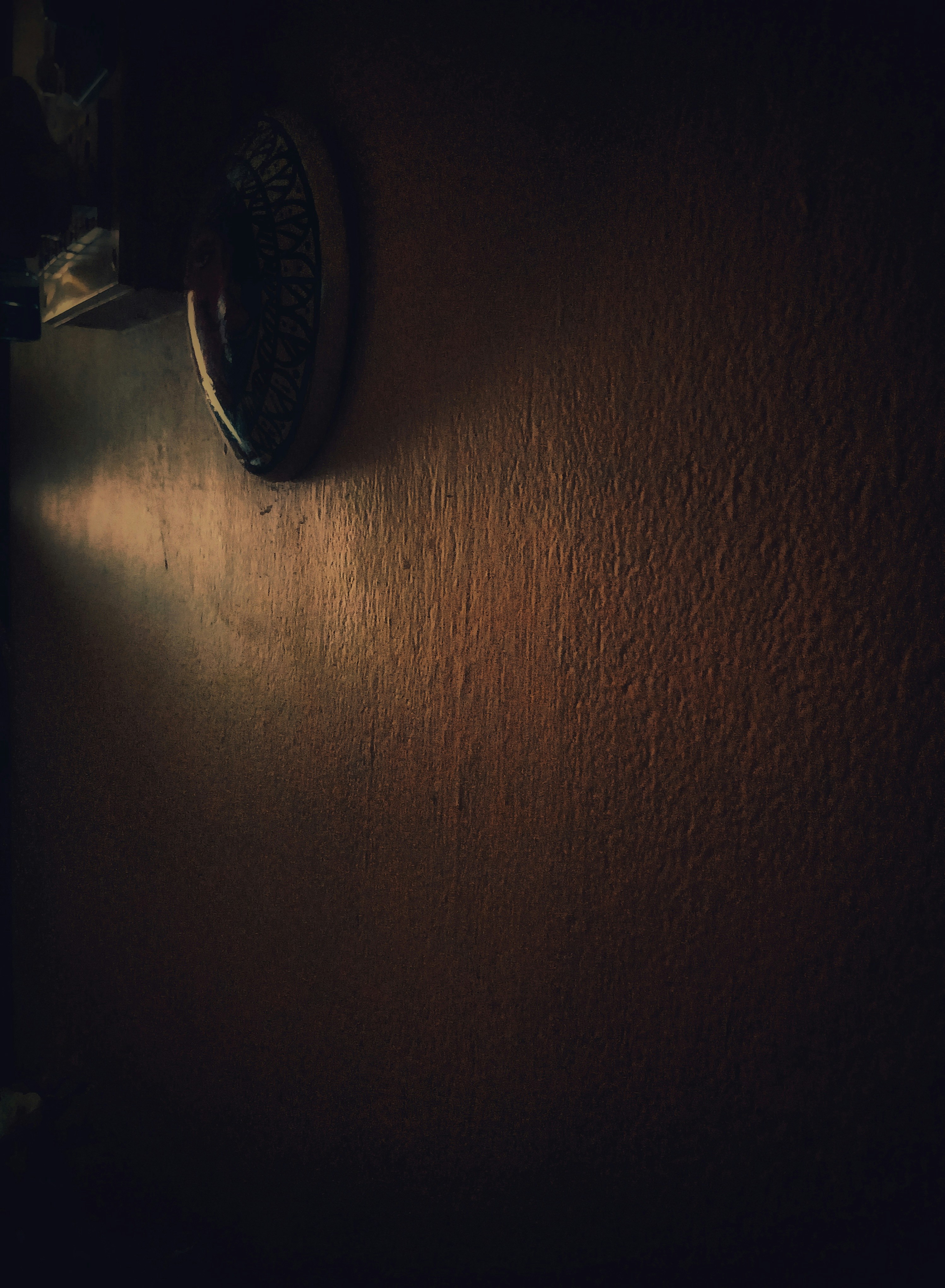 Dim Corner Glow: A Worn Wall and Partial Clock