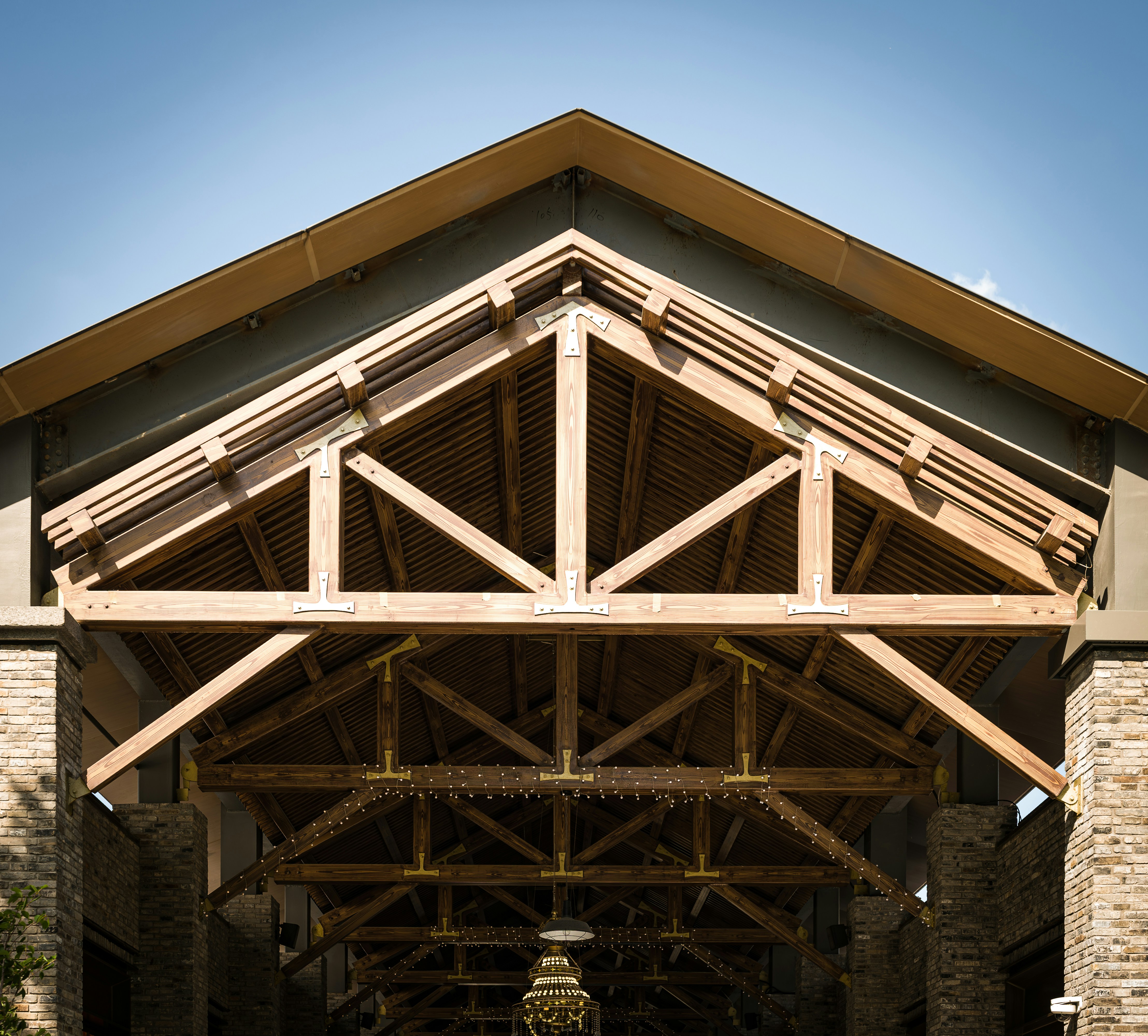 Timber Truss Crown: A Stark Welcome Through the Archway