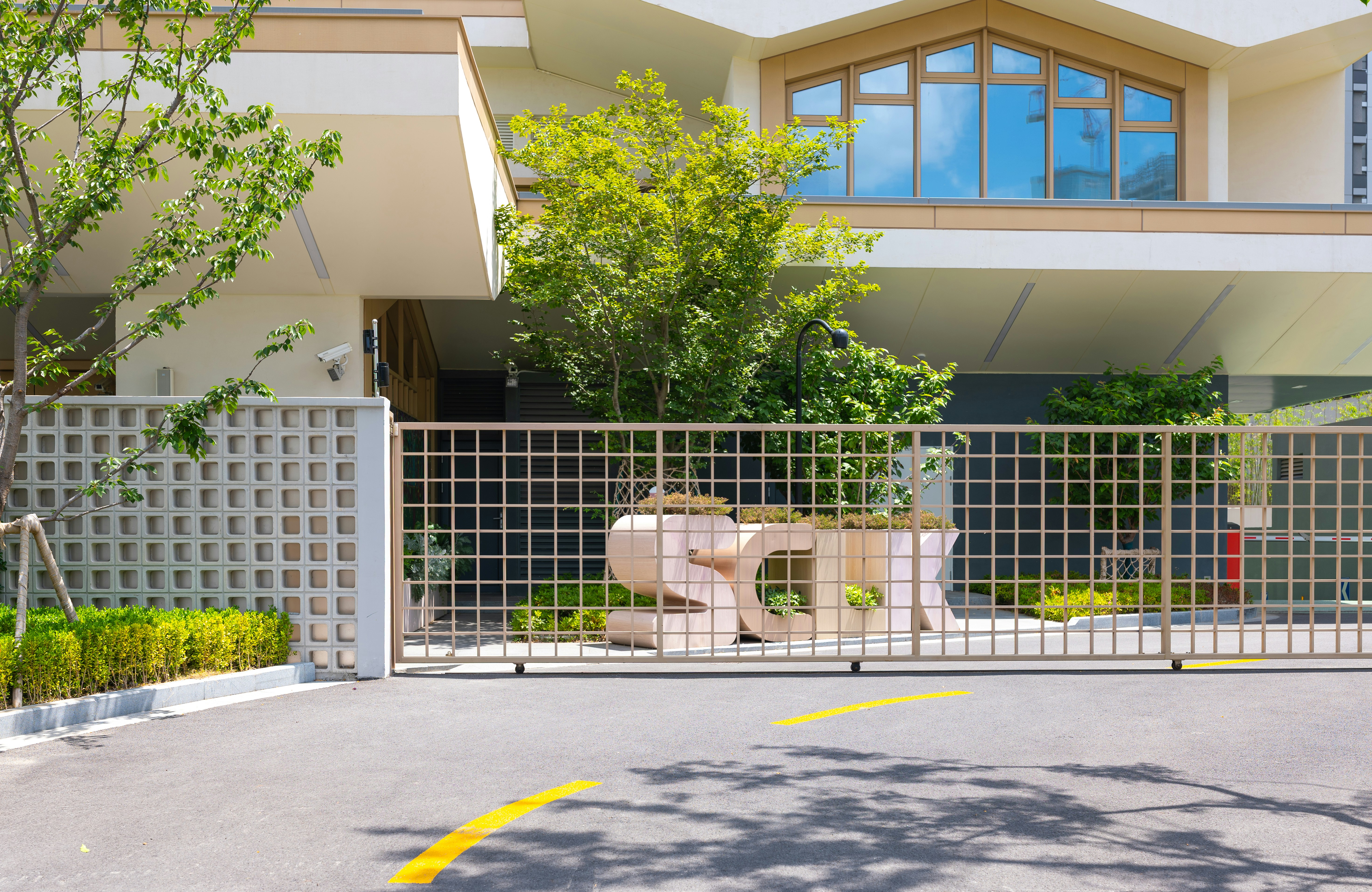 Gated Entrance to a Sunlit Modern Courtyard