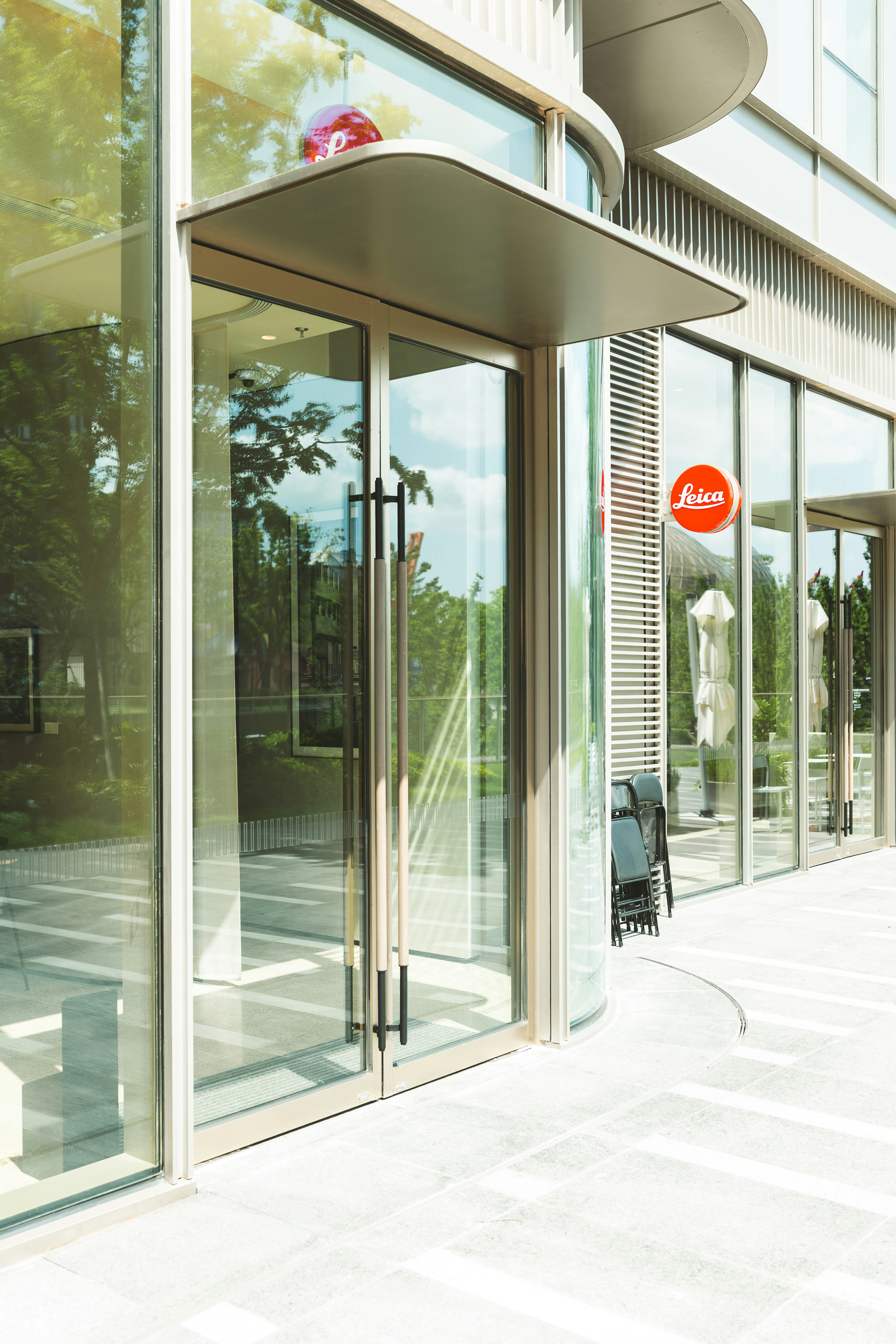 Glass Facade with Leica Circle: A Quiet Street-Level Portrait of Modern Minimalism