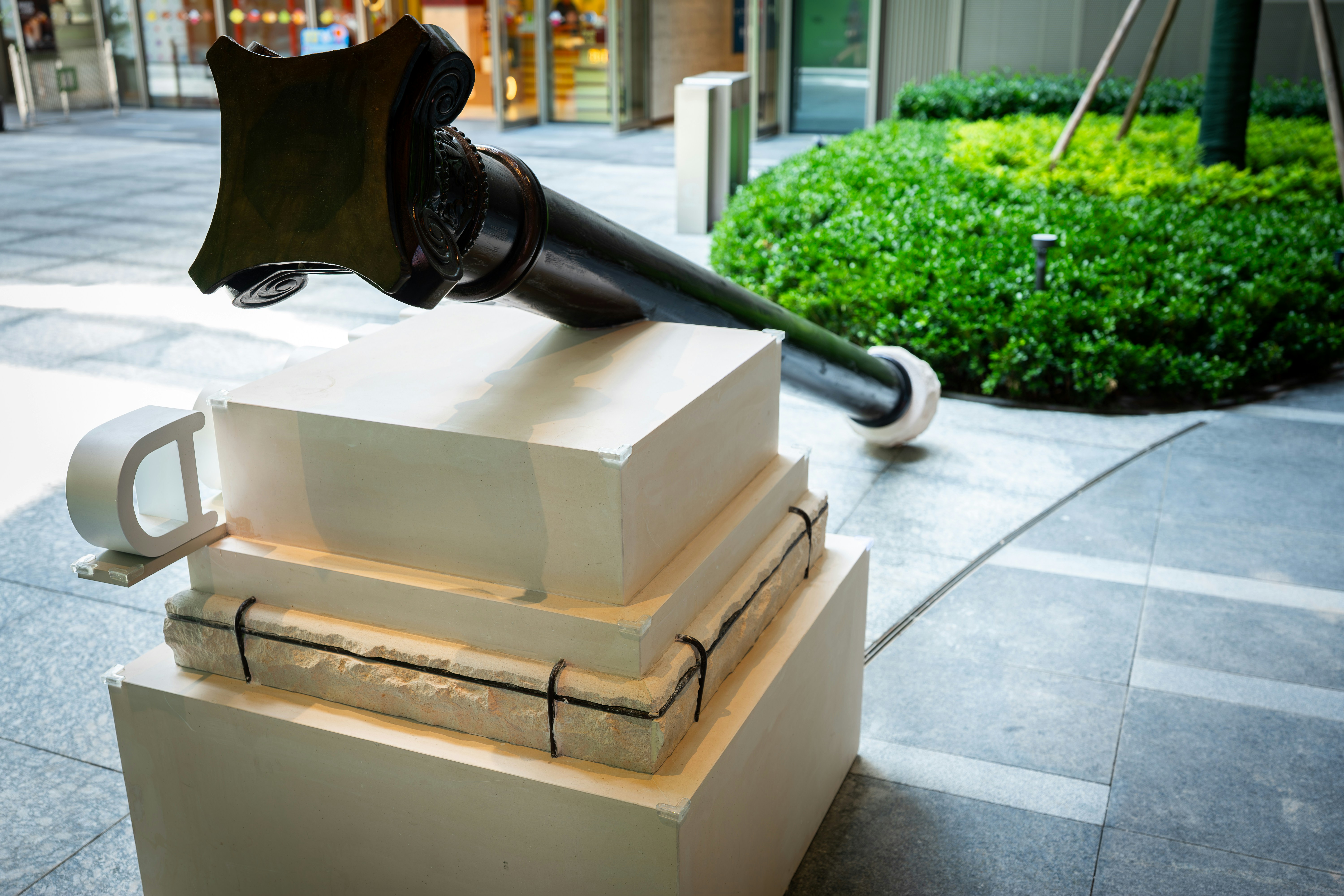 Artifact on Pedestal: A Stylized Cannon Resting Above a Stack of Books