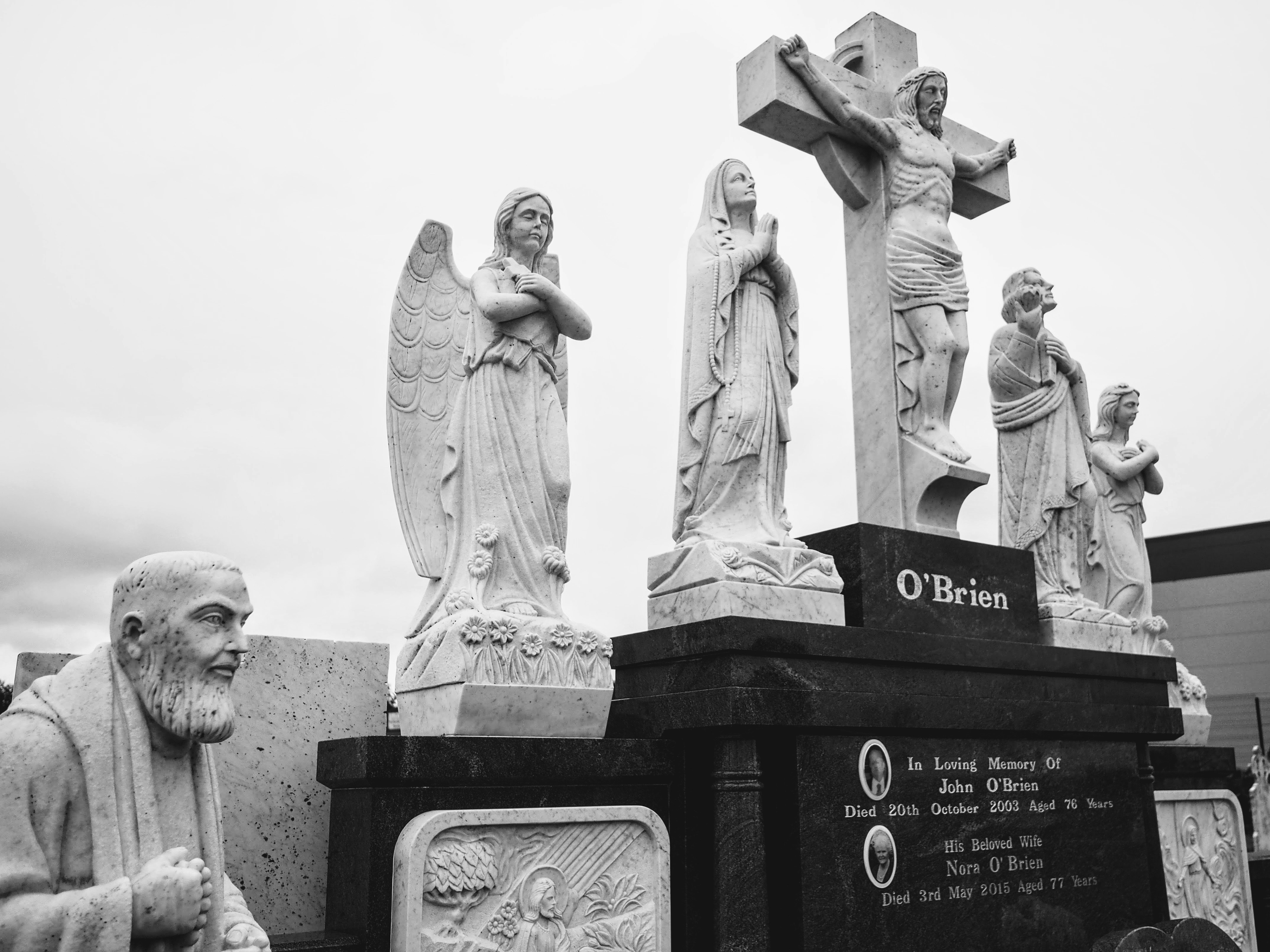 Stone Sentinels: A Quiet Sermon Over the Graveyard Gate